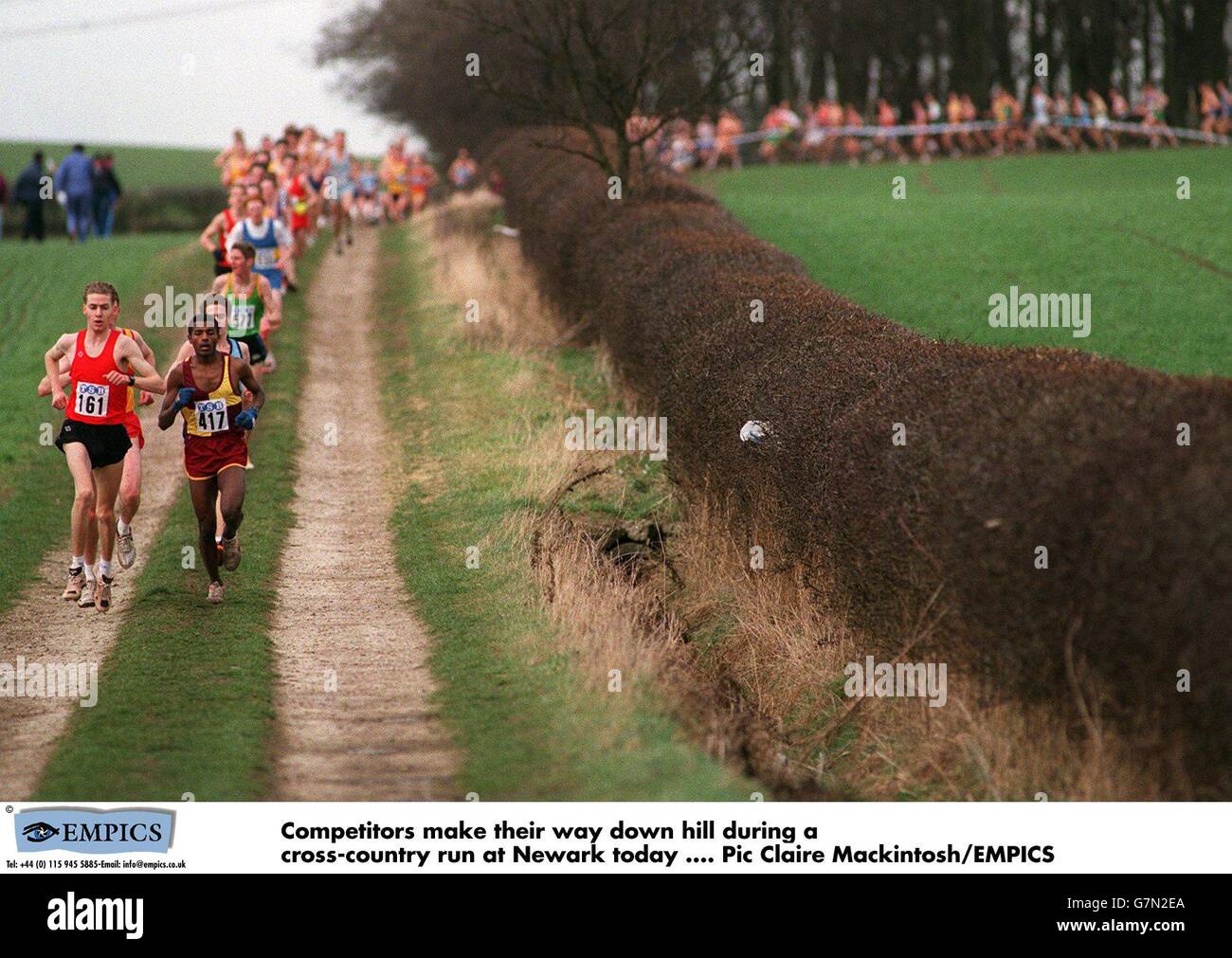 Competitors make their way down hill during a cross-country run at ...