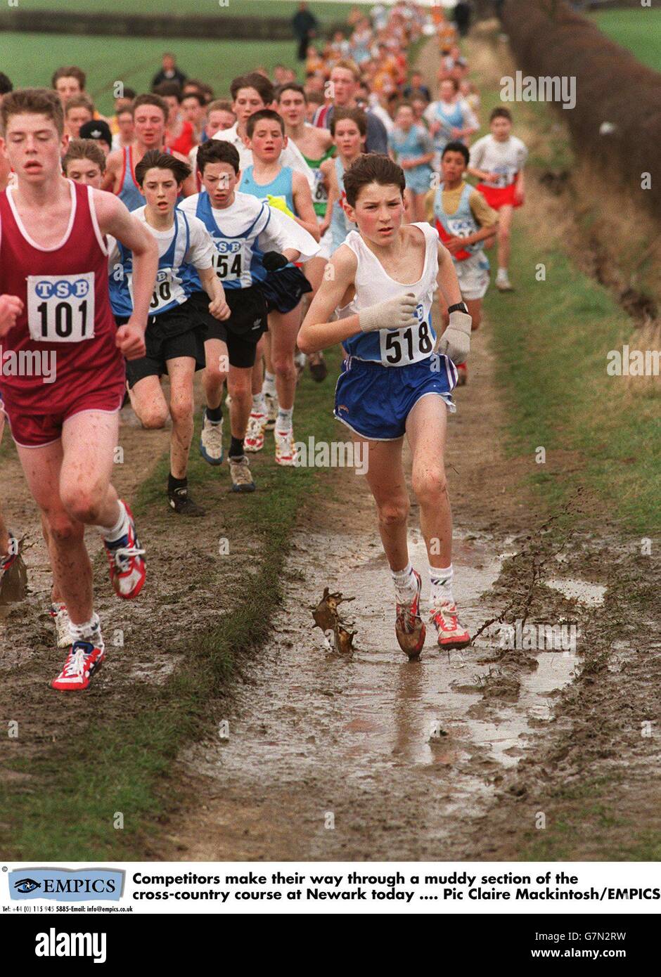 Competitors make their way through a muddy section of the cross-country ...
