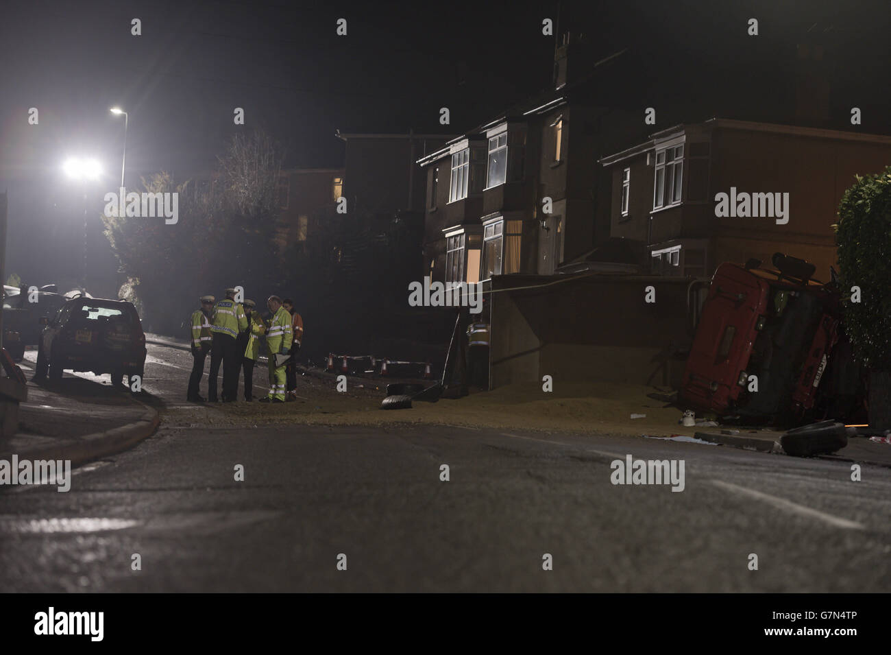 Police at the scene of a tipped over lorry after the tipper truck ...