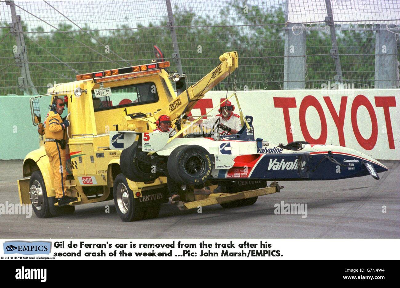 Gil de Ferran's car is removed from the track after his second crash of ...