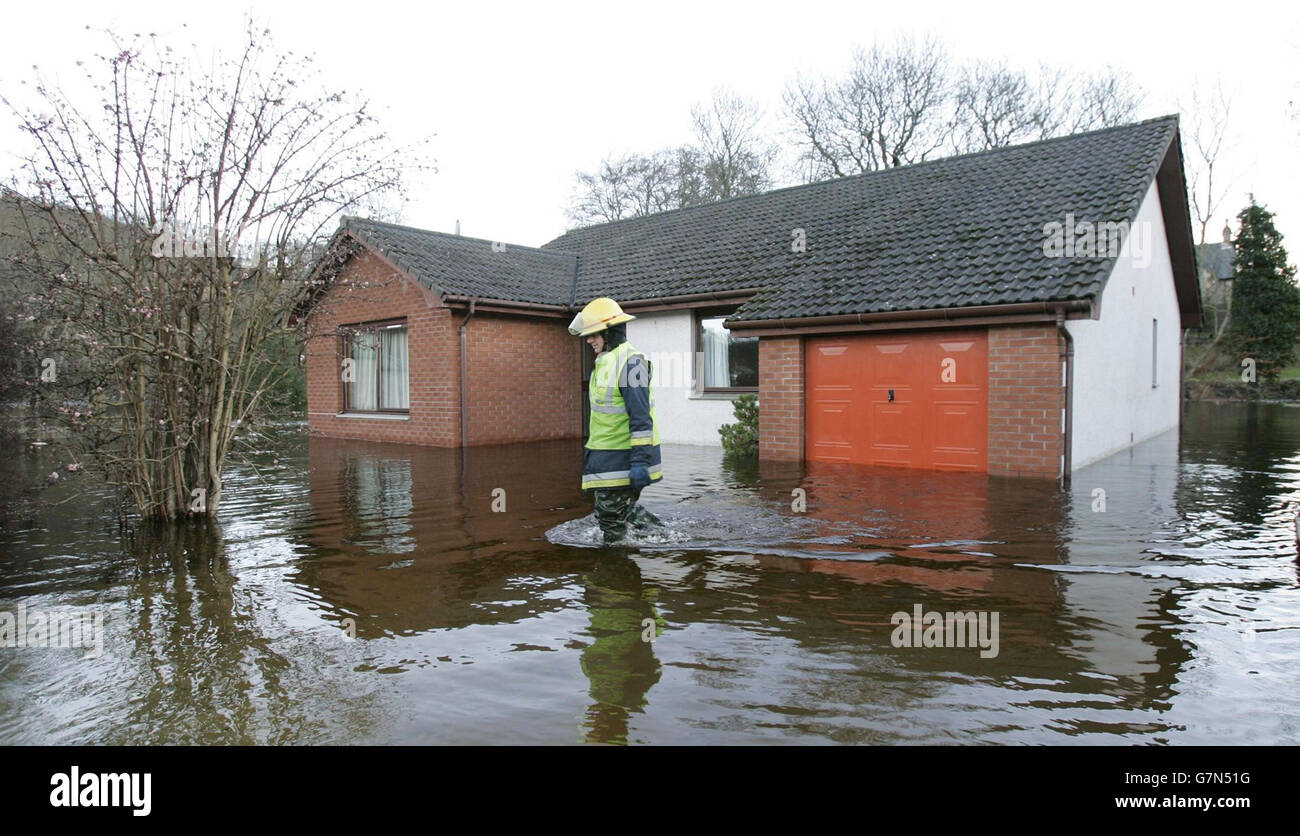 Firemen at a flooded house on Burnmouth Road in Birnham near Dunkeld ...