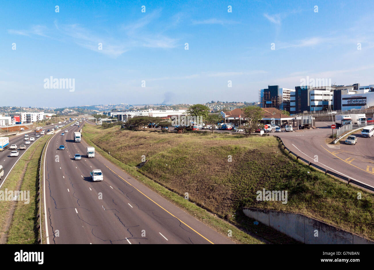 Many vehicles head north and south at mid day on the N2 highway at ...