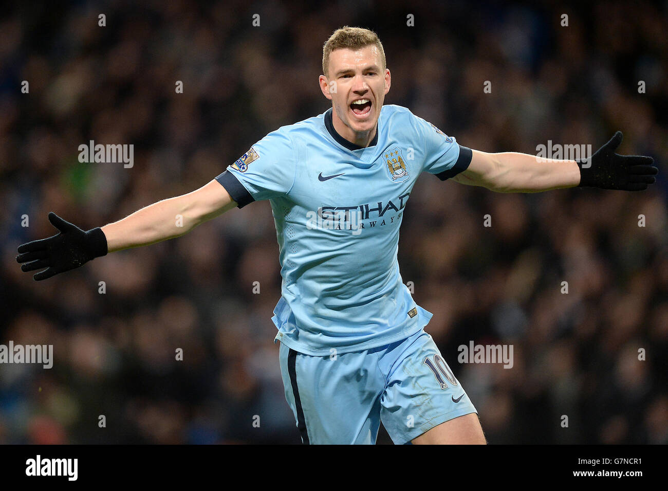 Manchester City's Edin Dzeko celebrates scoring his sides third goal of ...