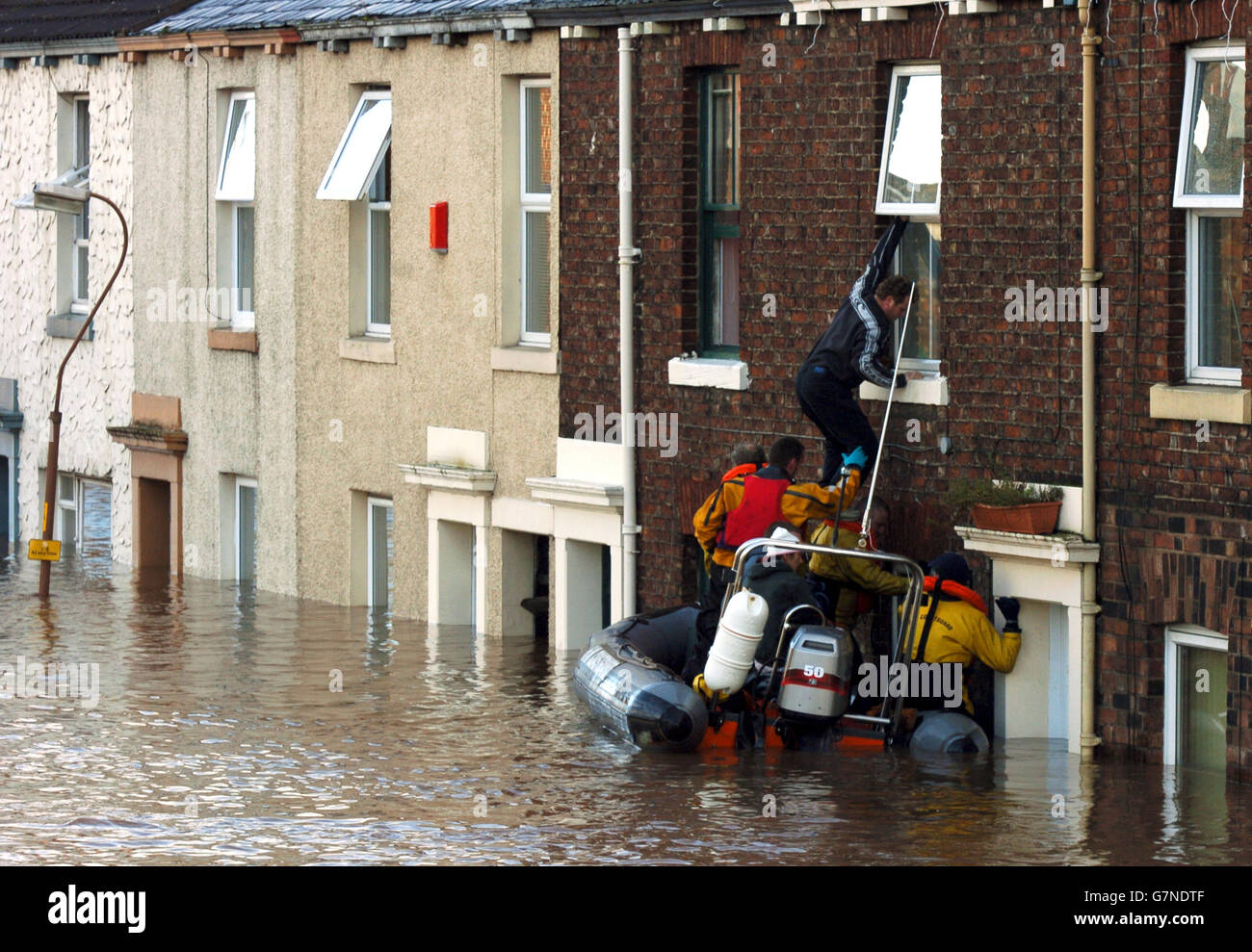 A householder is rescued from an upper house window by a Fire and ...