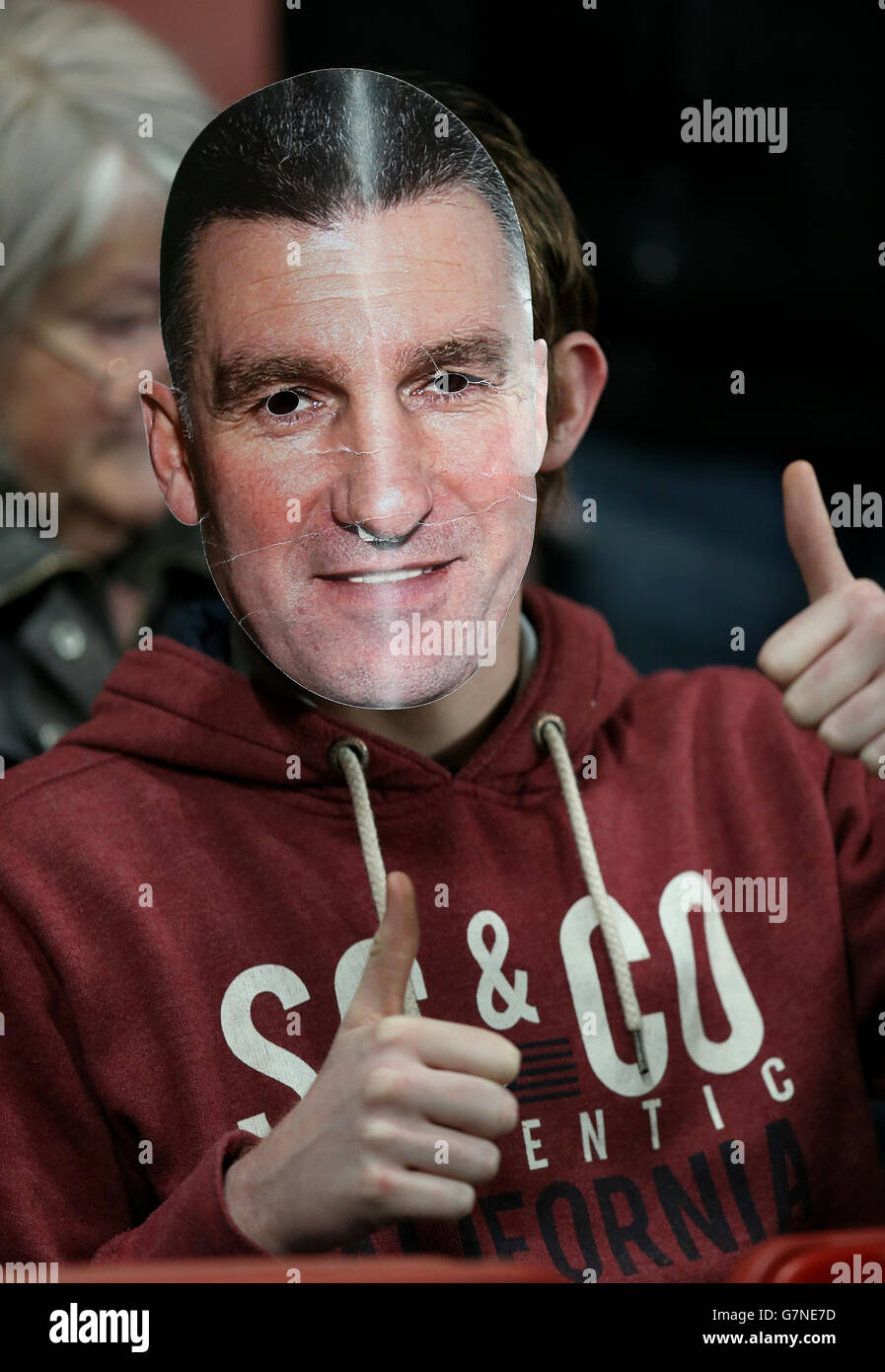 A football fan wears a mask of Leicester City manager Nigel Pearson in ...