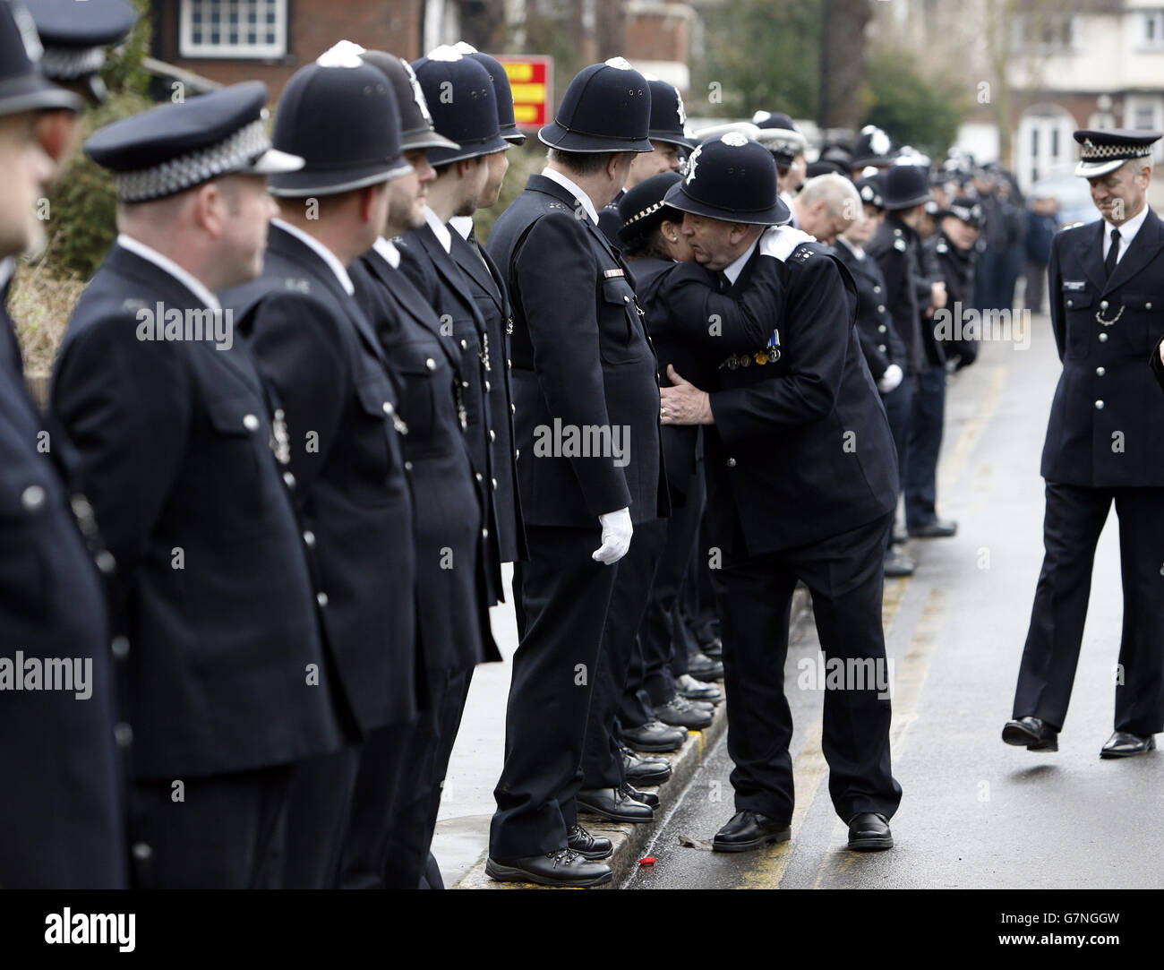 PC Robert Brown, is hugged by colleagues at Croydon Police station in ...