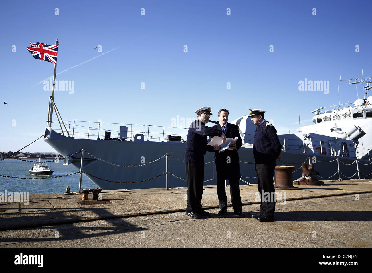 Prime Minister David Cameron looks at plans with Captain Iain Greenlees ...