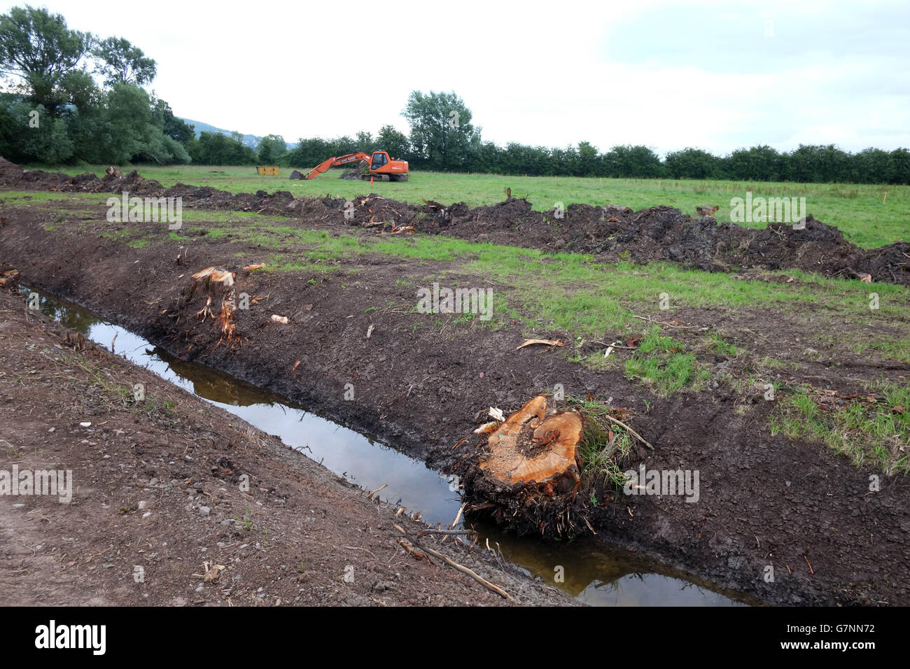 Orange 360 machine or digger being used for agricultural ditch or rhyne ...