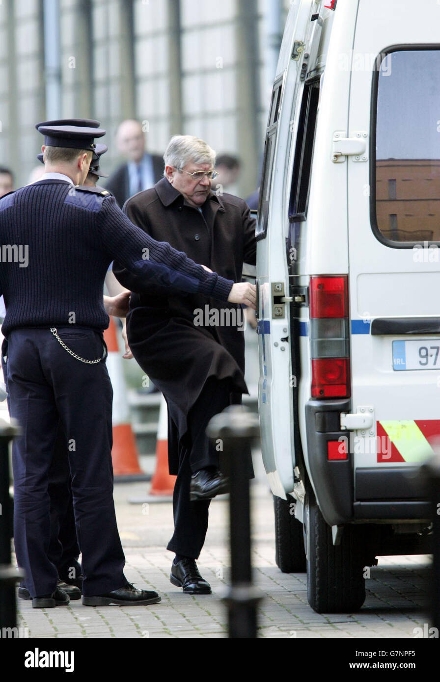 Former Irish government minister Ray Burke is led into a prison van ...