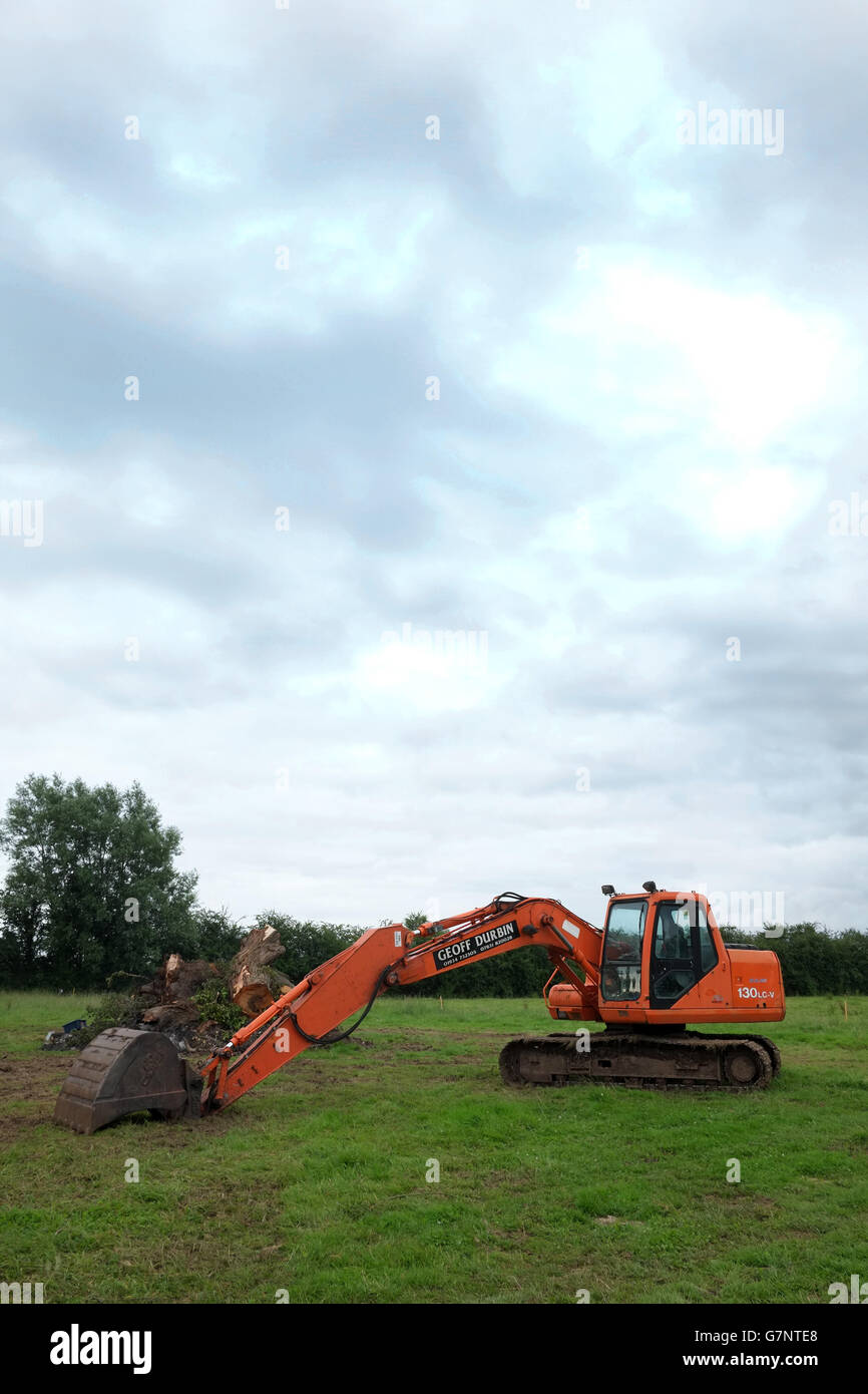 26th June 2016 - Large orange digger or 360 excavator in a field ready ...