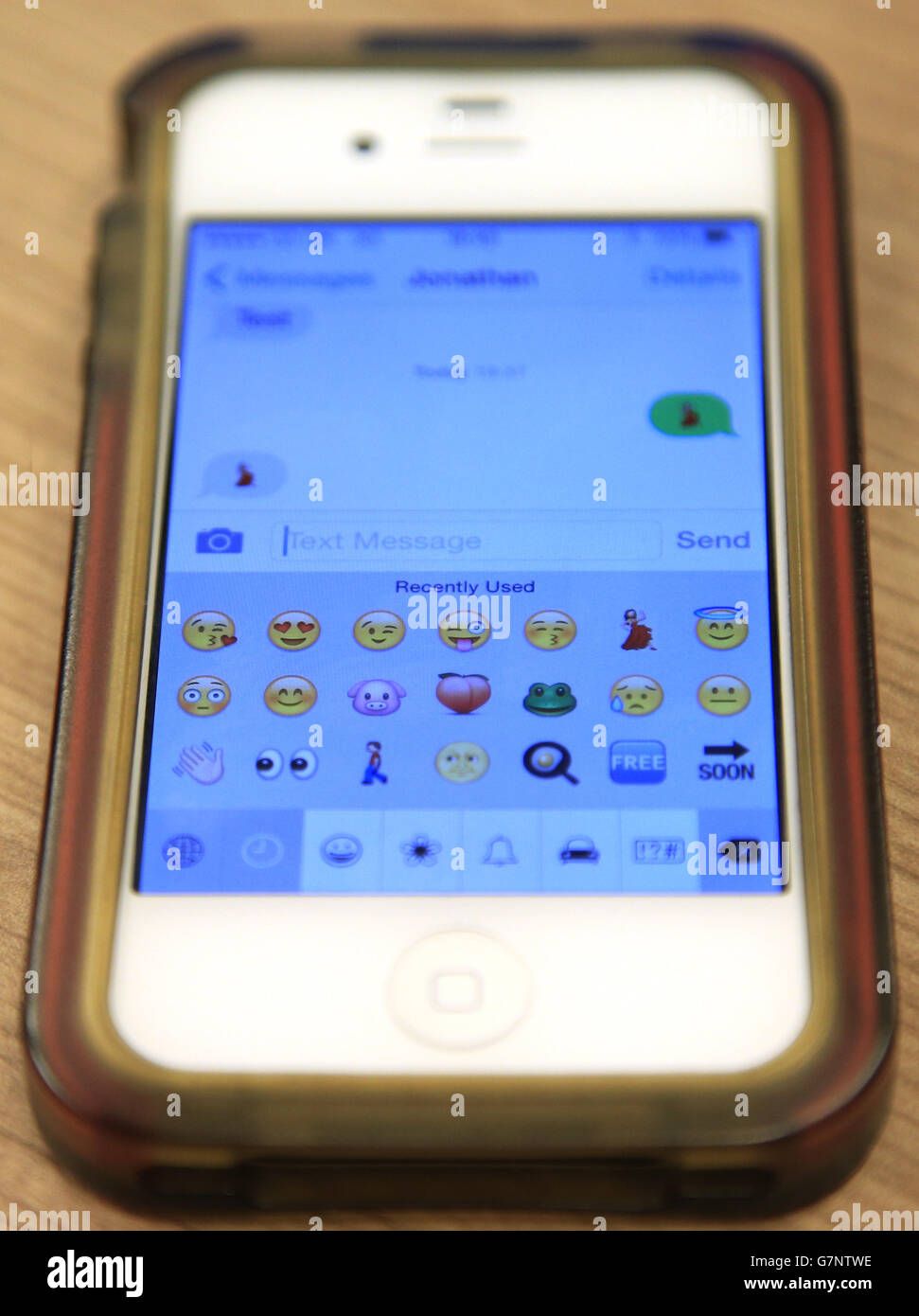 Emoji, also known as 'emoticons', being used on an iPhone 4s Stock ...