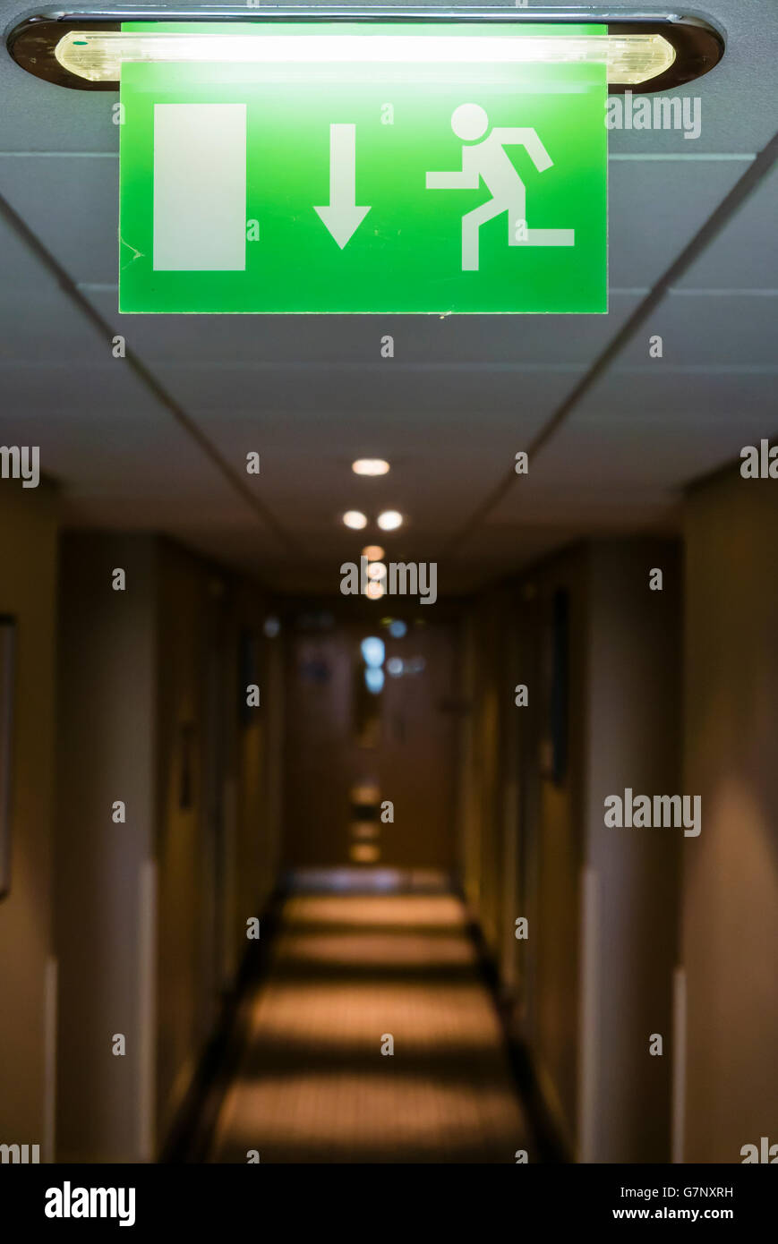 Fire escape sign in a dark hotel corridor Stock Photo - Alamy