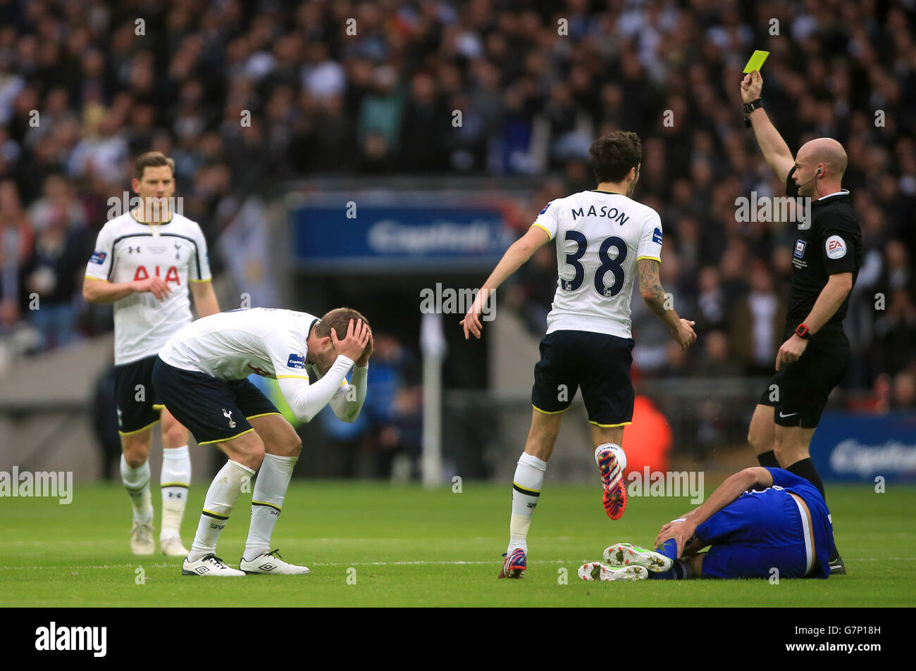 Tottenham Hotspur's Eric Dier (left) is shown the yellow card by ...