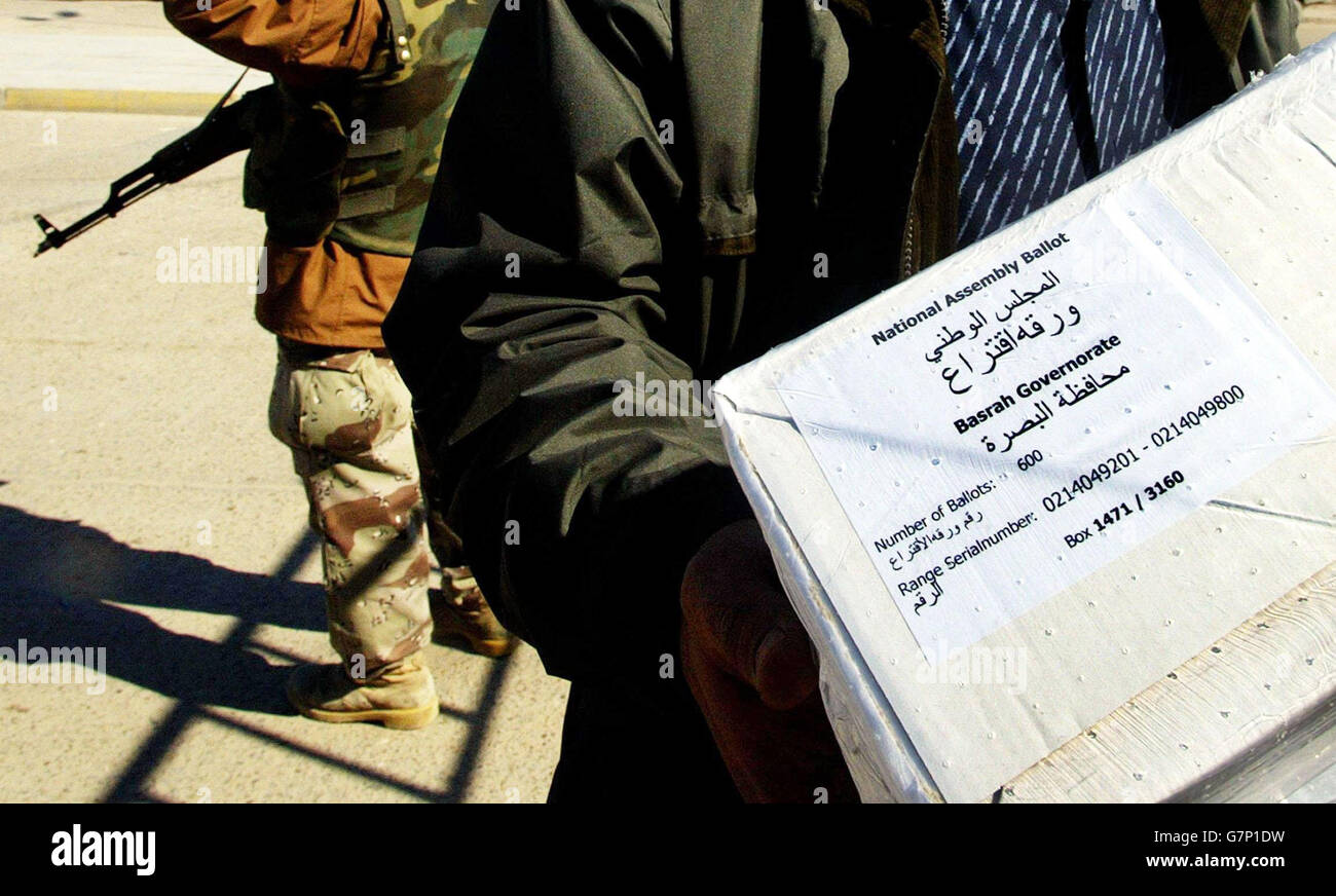 An Iraqi election official delivers ballot papers to a a polling ...