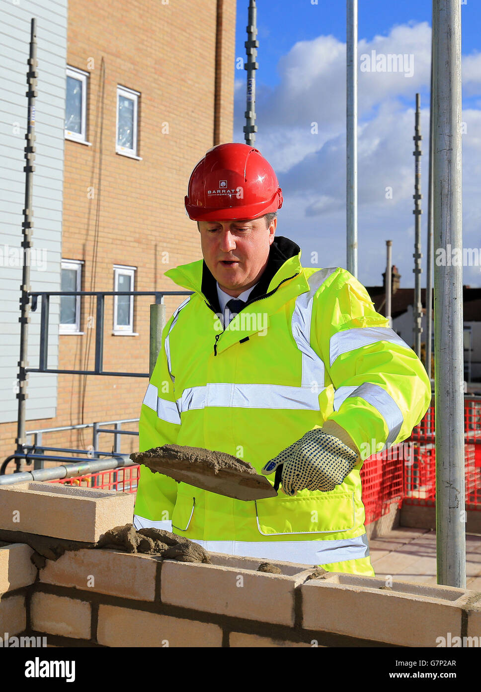 Prime Minister David Cameron tries his hand at brick laying during a ...