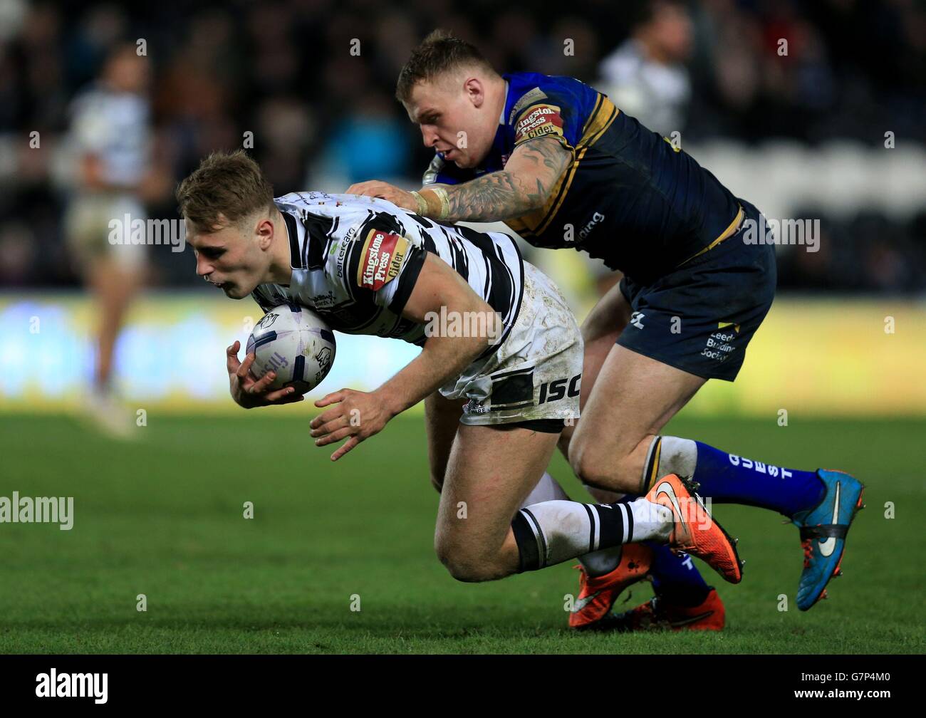Hull FC's Jansin Turgut is tackled by Leeds Rhino's Brad Singleton ...