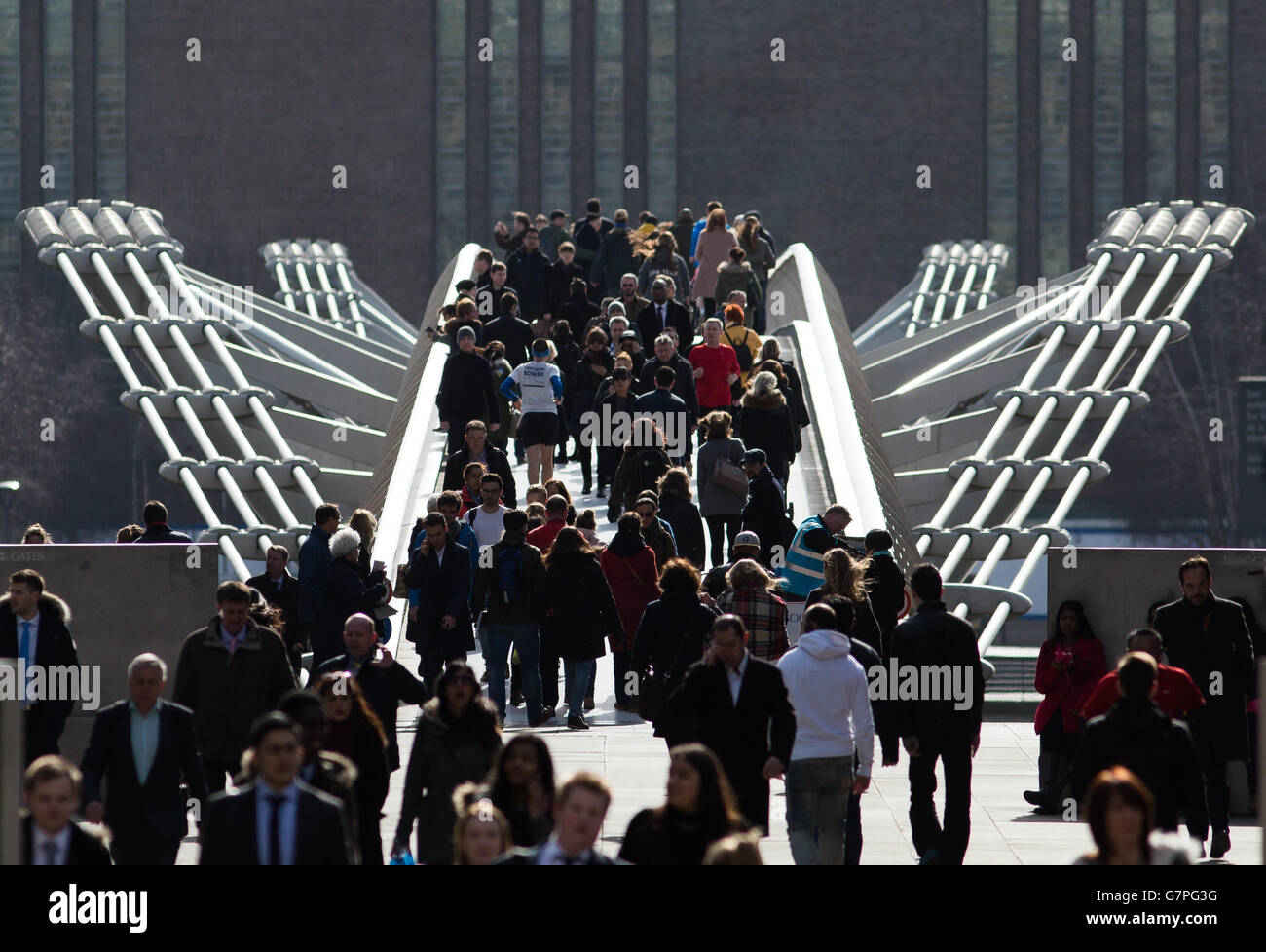 People cross over Millennium Bridge in central London Stock Photo - Alamy