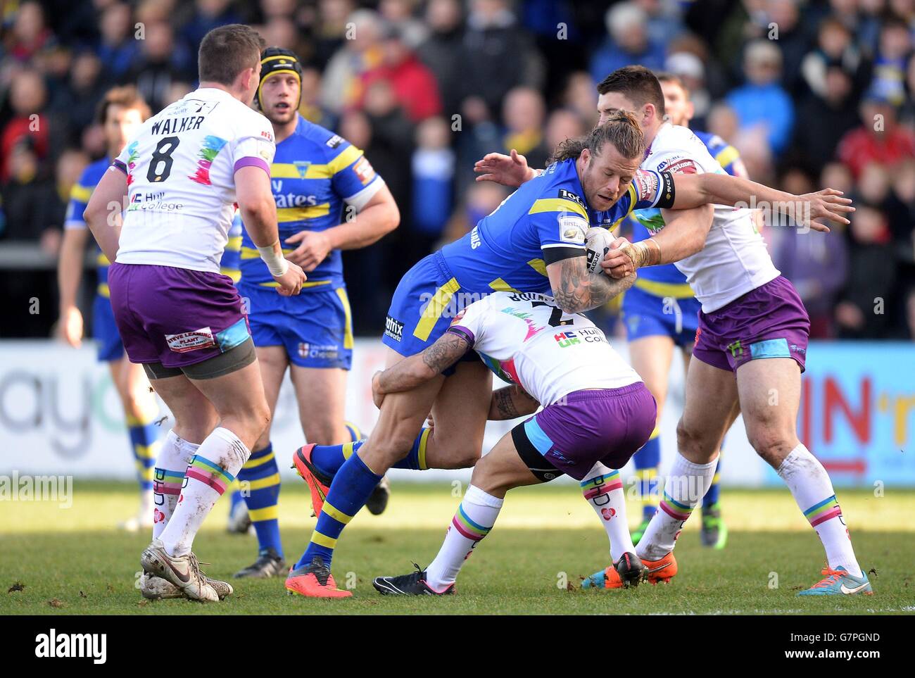 Warrington Wolves' Ashton Sims (centre) is tacked by Hull Kingston ...