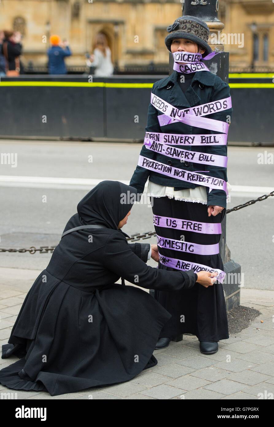 Domestic workers dressed as suffragettes protest outside the Houses of ...