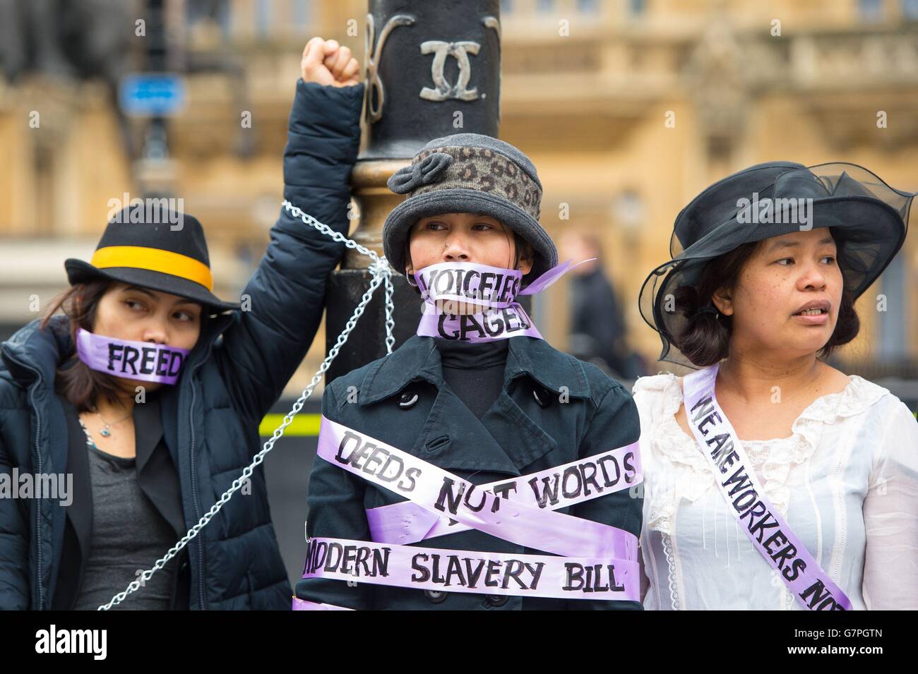 Domestic workers dressed as suffragettes protest outside the Houses of ...