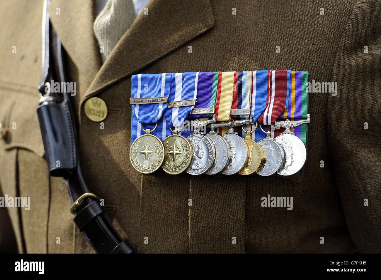Detailed view of medals on an Army officers jacket as family and ...
