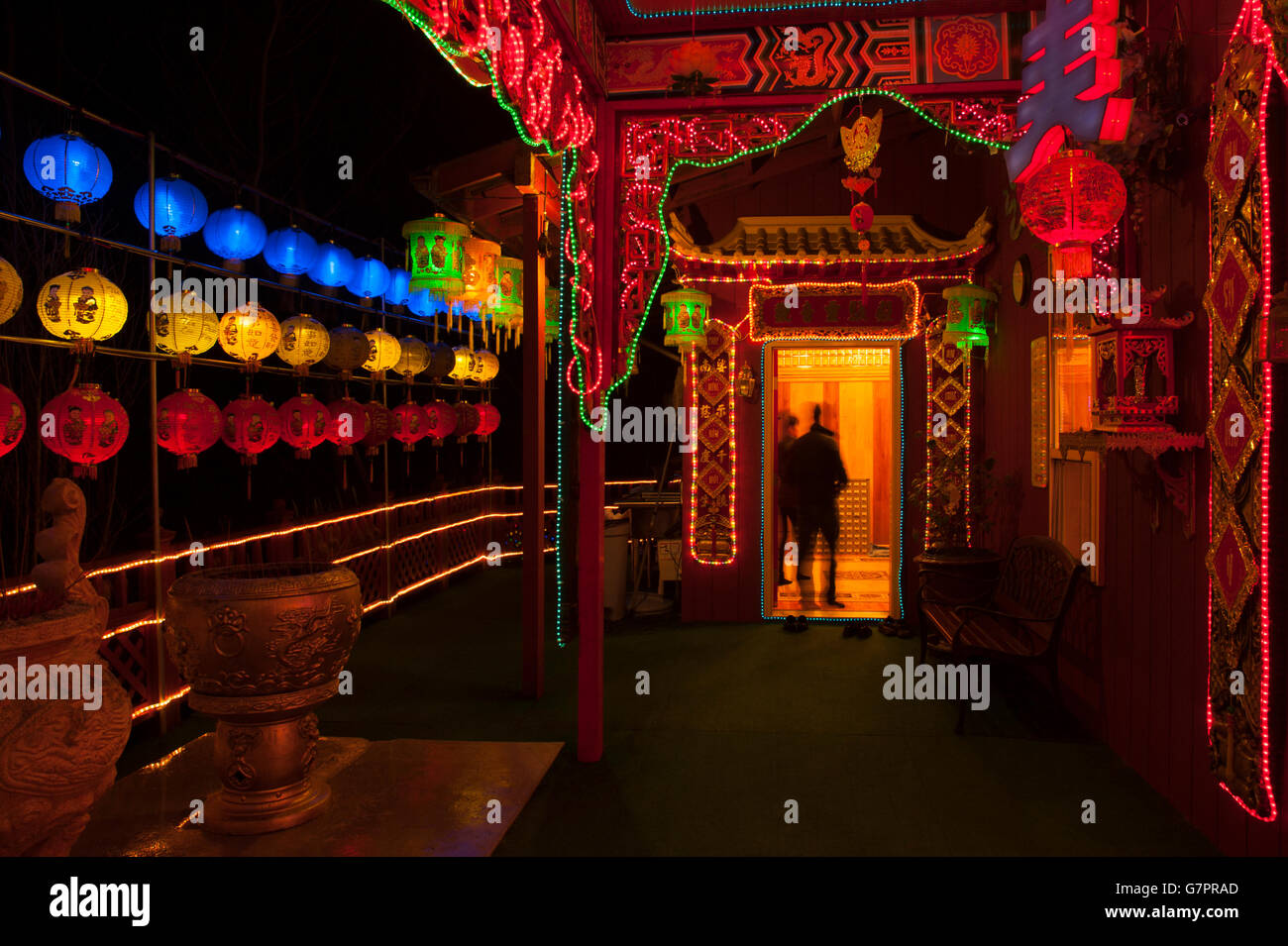 Multicolored lights with entrance into buddhist temple for prayer with ...