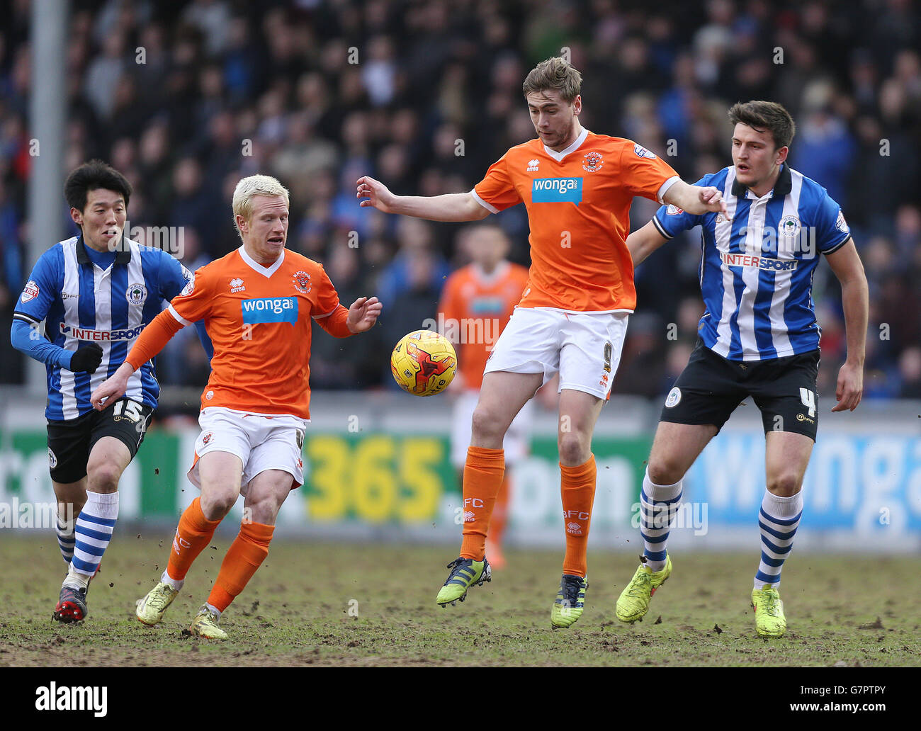 Blackpool's David Perkins (left) and Steven Davies battle with Wigan ...