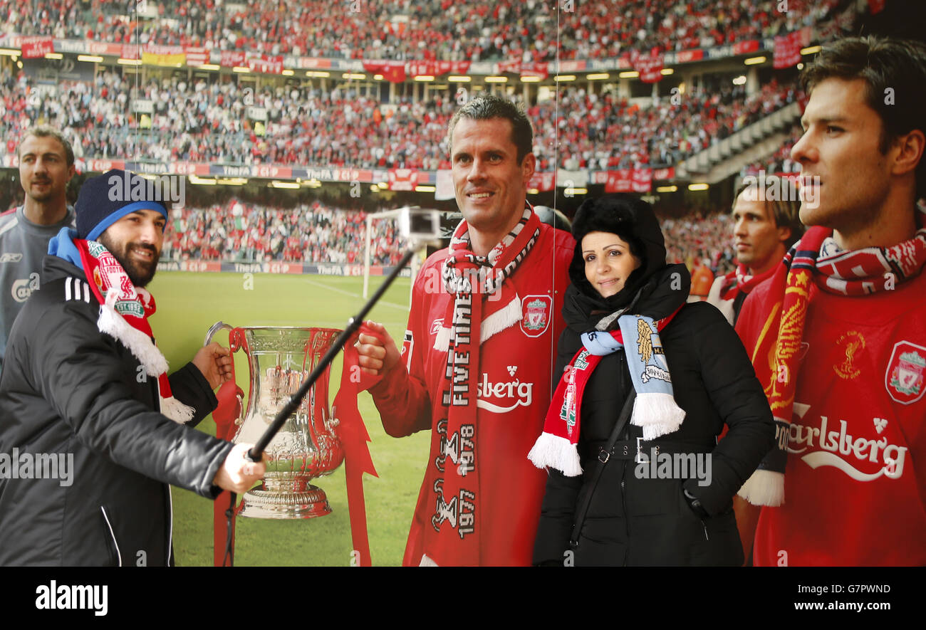 Fans pose for photographs outside Anfield before the Barclays Premier ...