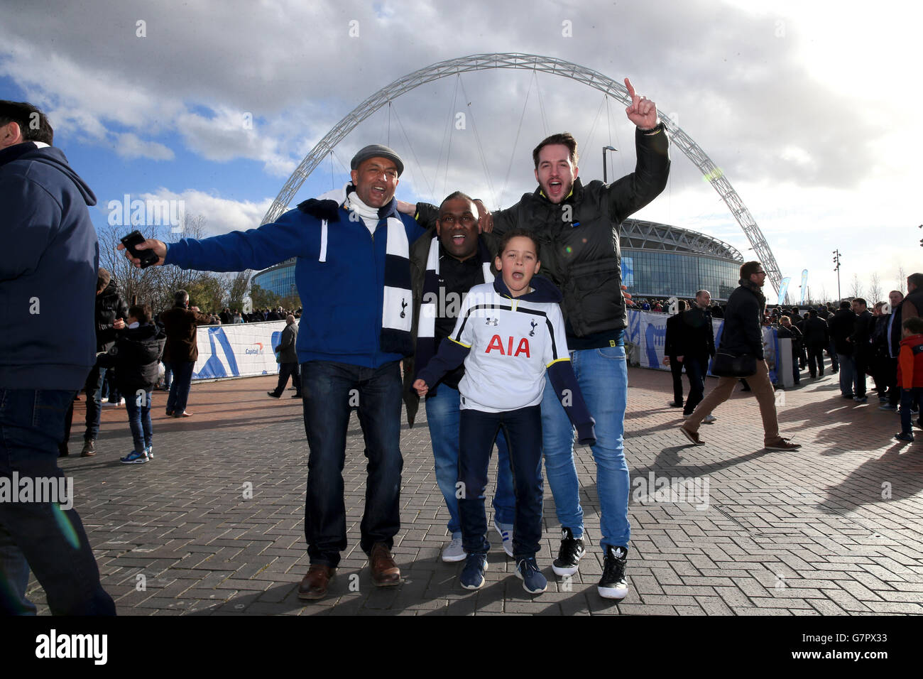 Tottenham Hotspur fans pose for a photograph as they make their way ...