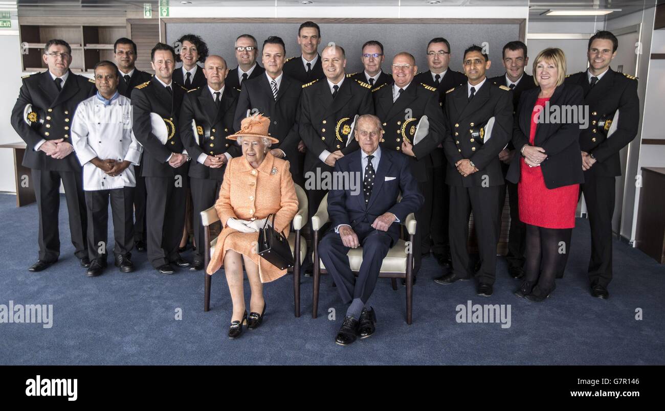 Queen Elizabeth II pose with senior crew members during a tour ...