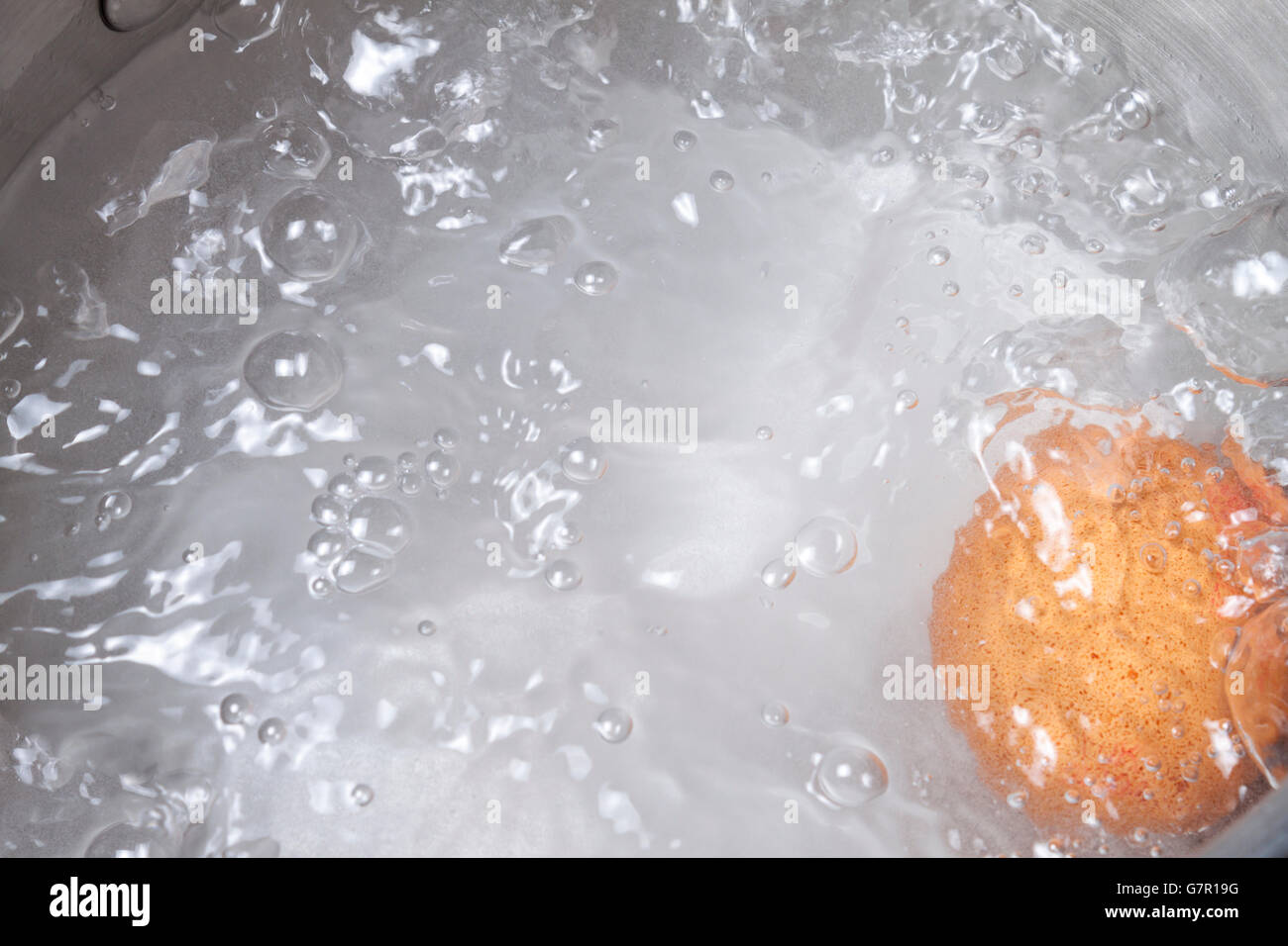 Close up shot of an egg boiling in a stainless steel saucepan Stock ...