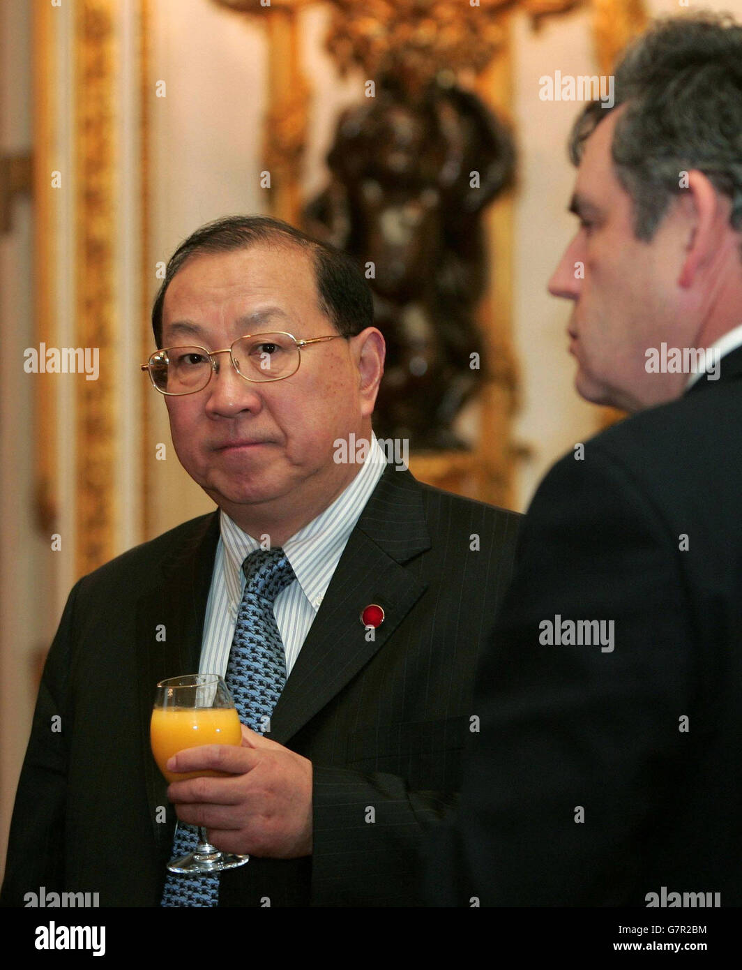 China's Finance Minister Jin Renqing (L) stands with Britain's ...