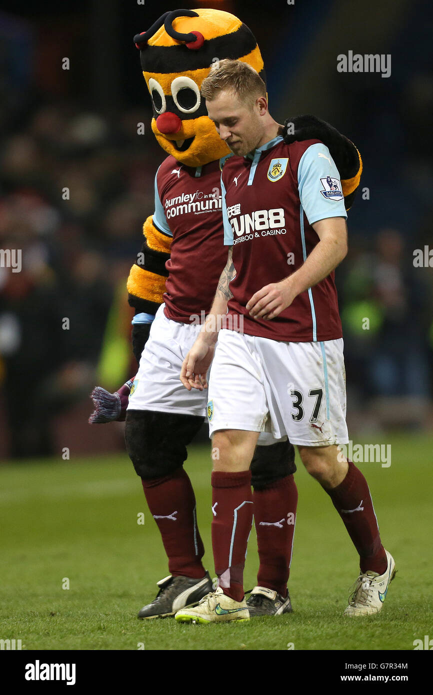 Burnley's Scott Arfield (right) walks off with mascot Bertie Bee Stock ...