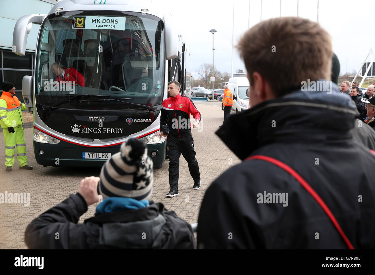 Milton Keynes Dons fans watch as their players arrive at the Ricoh ...