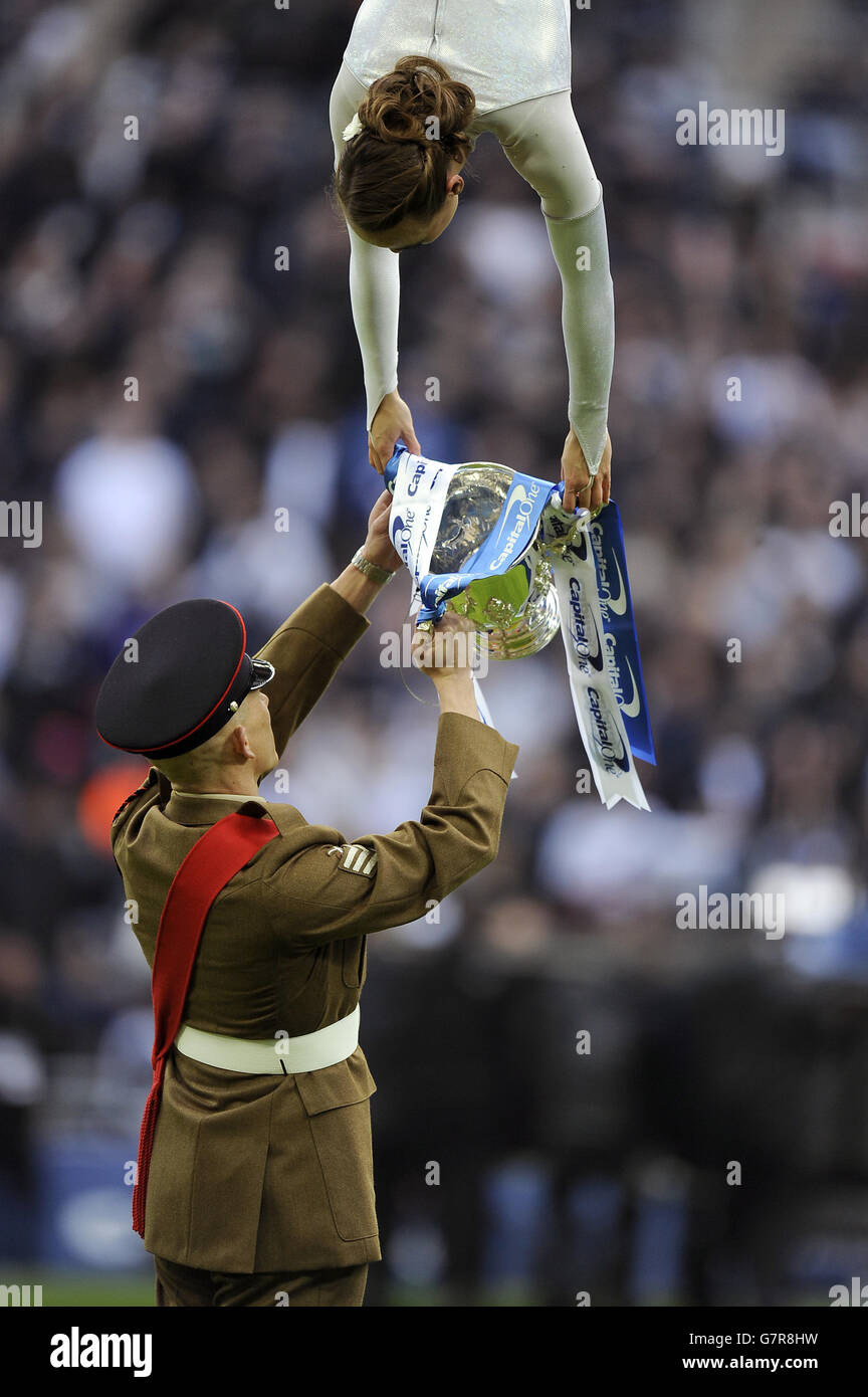 A high wire trapeze artist delivers the Capital One Cup before kick off ...