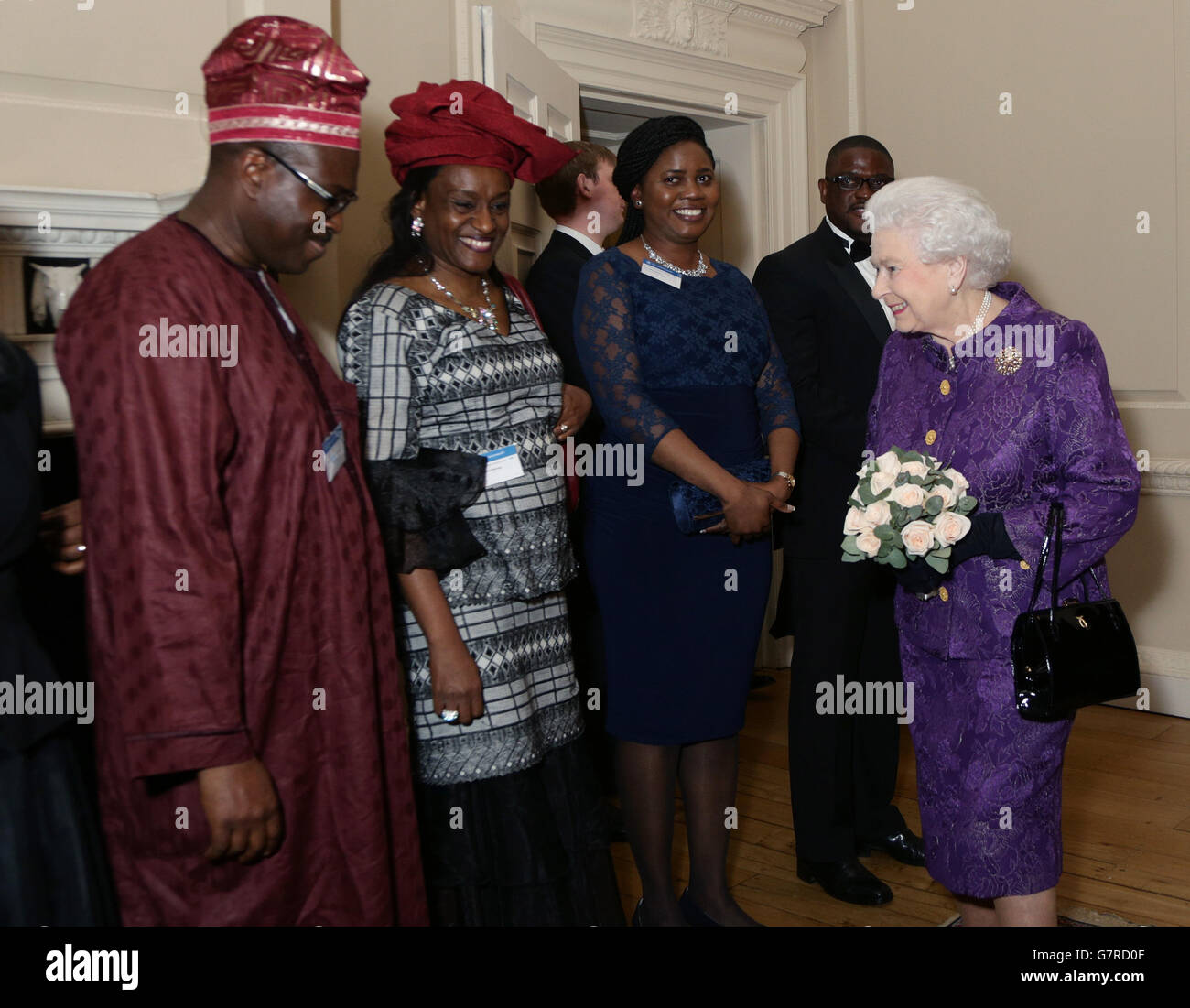 Queen Elizabeth II speaking with guests during a reception to mark ...
