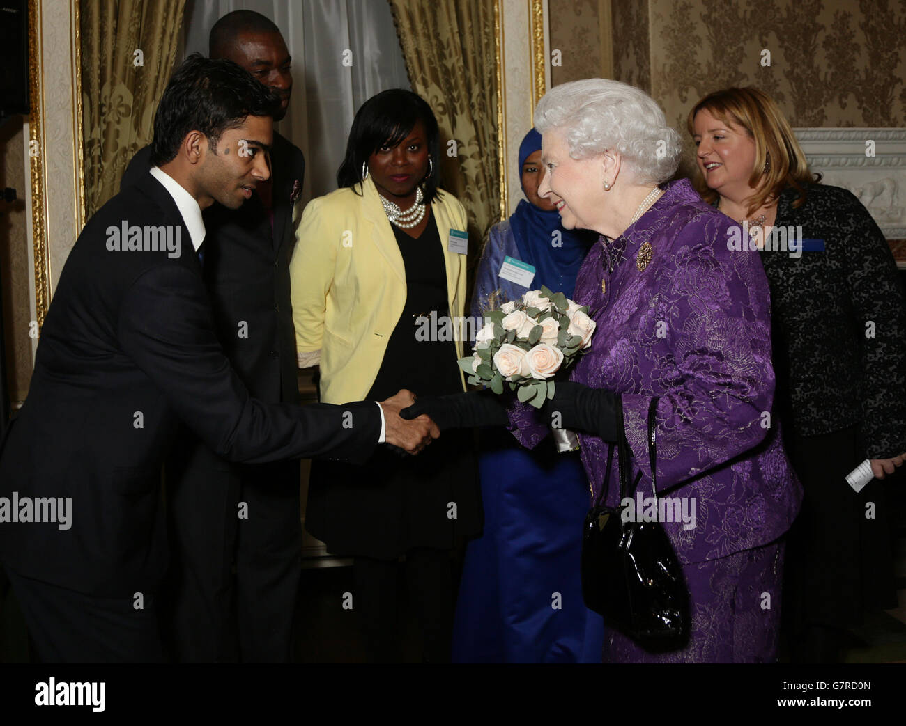 Queen Elizabeth II speaking with guests during a reception to mark ...