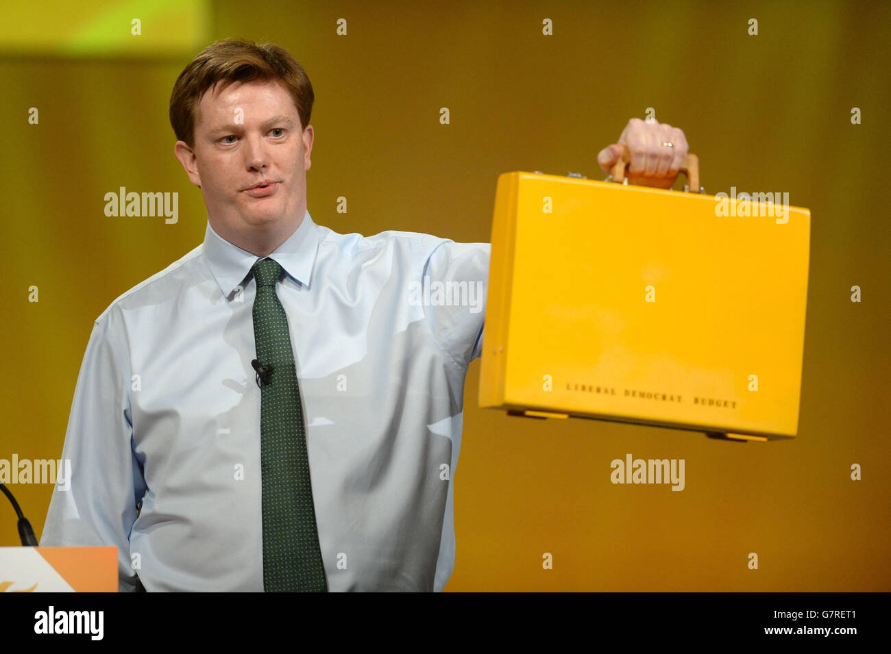 Chief Secretary to the Treasury Danny Alexander holding up a yellow ...