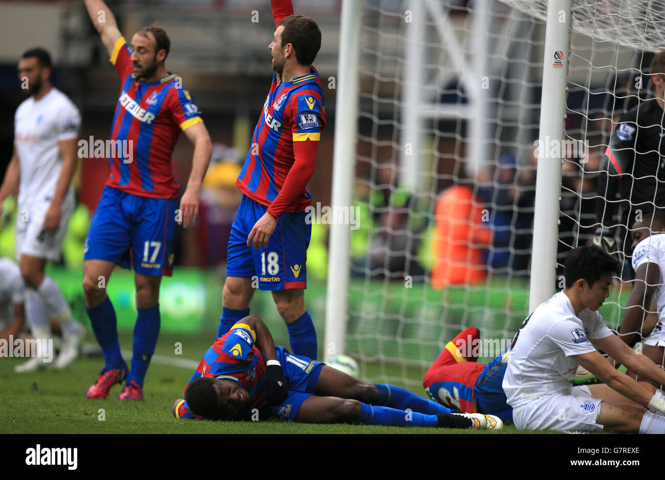 Crystal Palace's Wilfried Zaha (on floor) shows his pain after ...