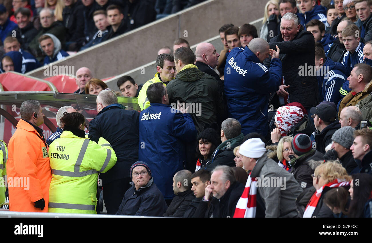 Angry Sunderland fans try to get to the dug out where manager Gus Poyet ...