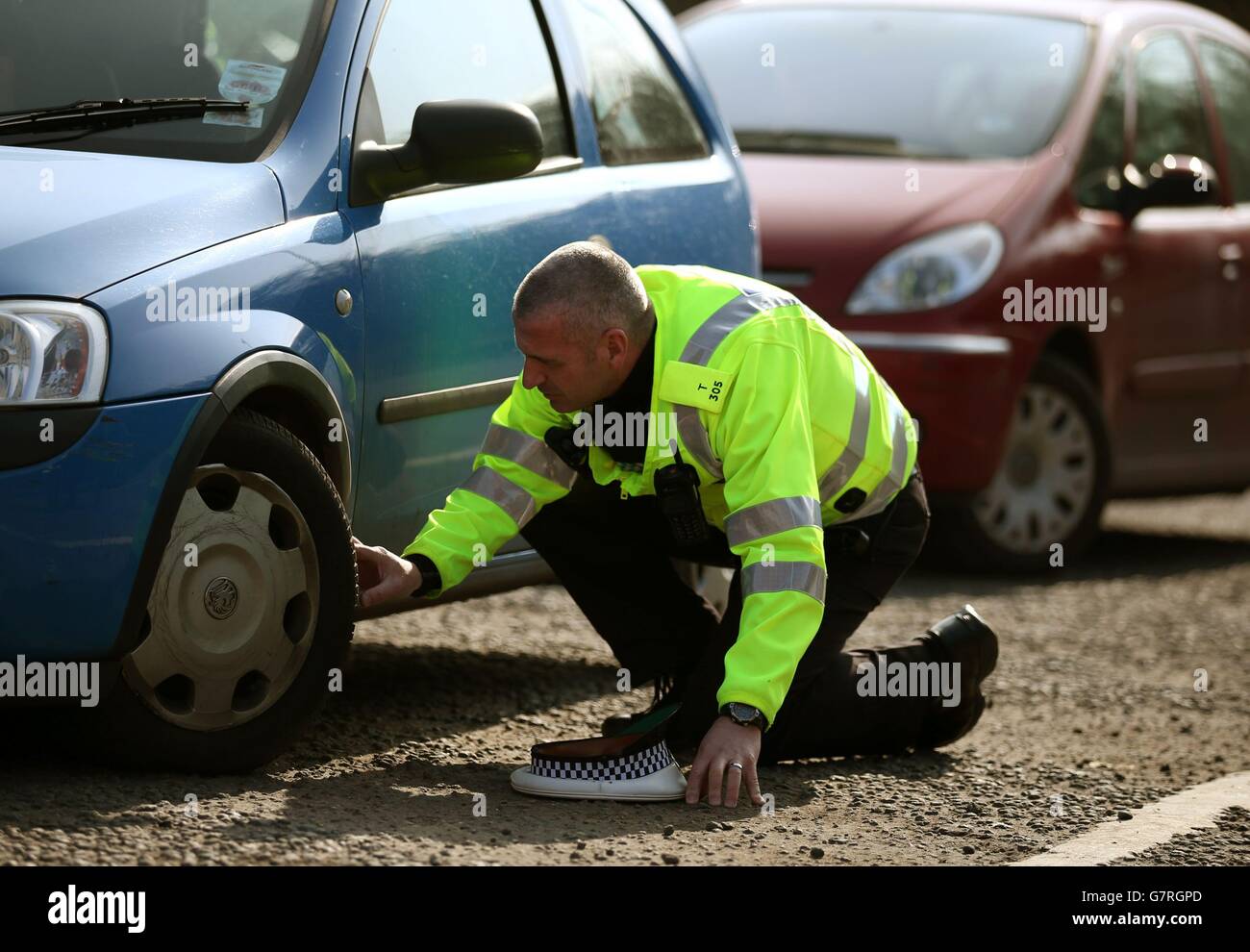 Police officers check vehicles at a roadside policing campaign ...