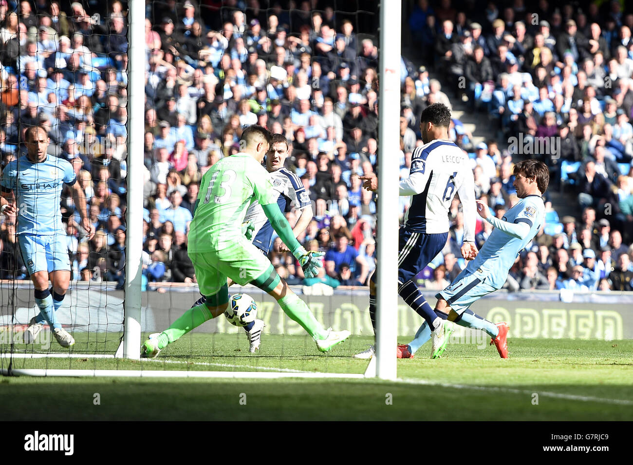 Manchester City's David Silva (right) has a shot saved by West Bromwich ...