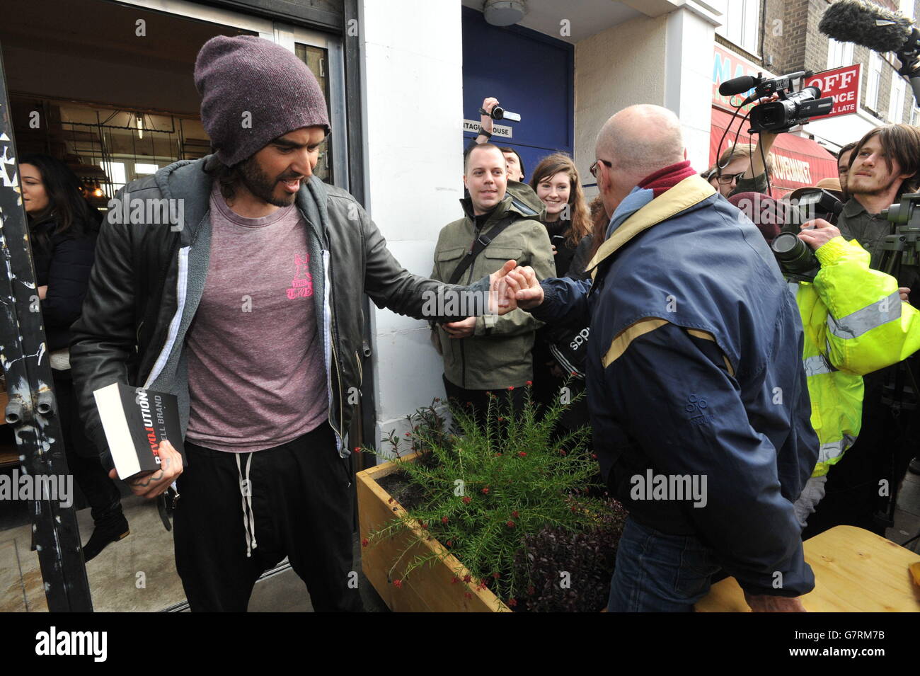 Russell Brand with his father Ron Brand as he arrives to open the Trew ...