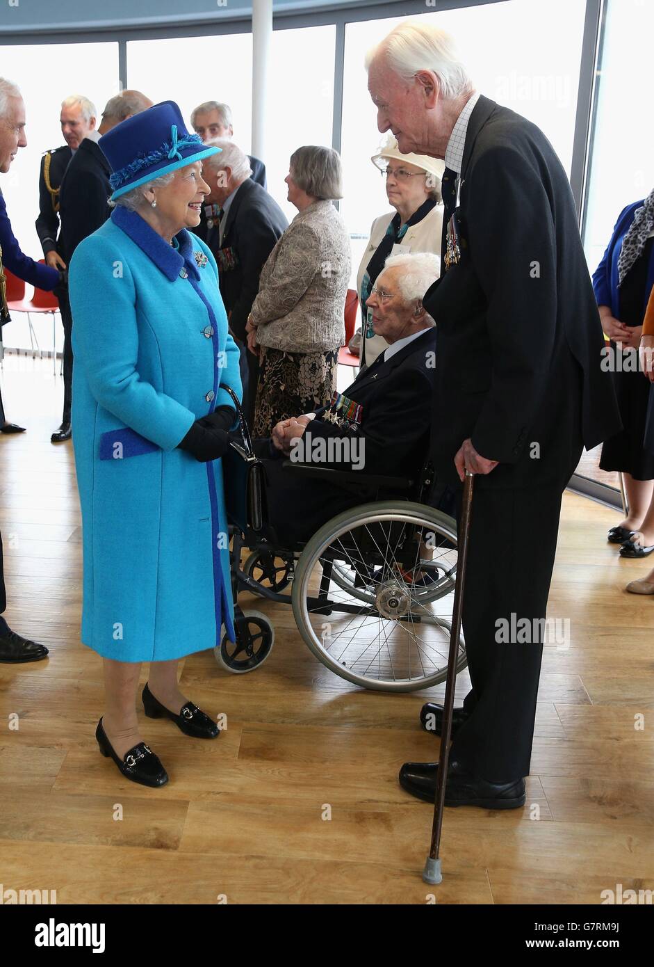 Queen Elizabeth II meets Wing Commander Tom Neil as she visits the ...