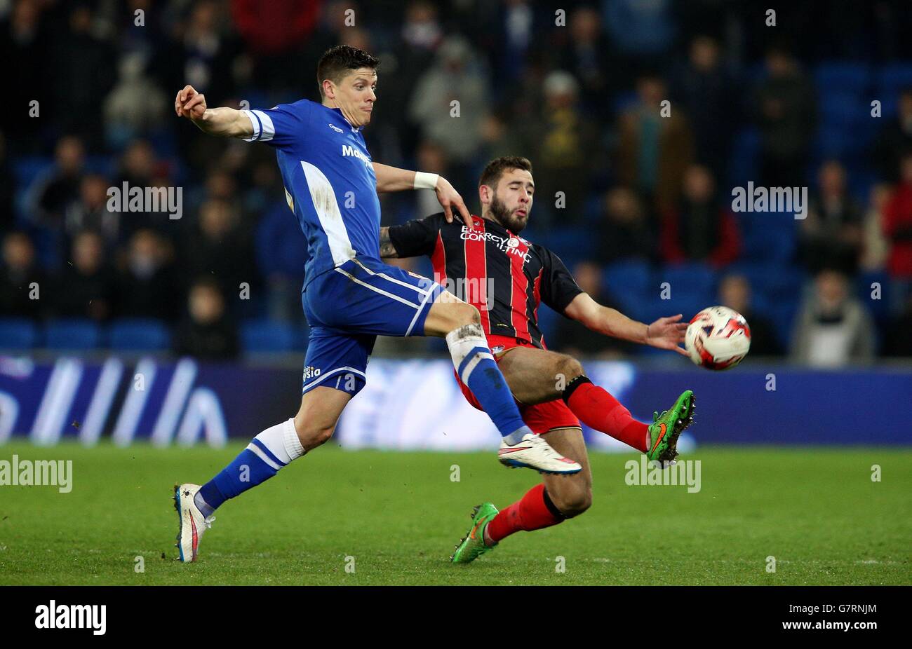 Cardiff City's Alex Revell is challenged by Bournemouth's Steve Cook ...