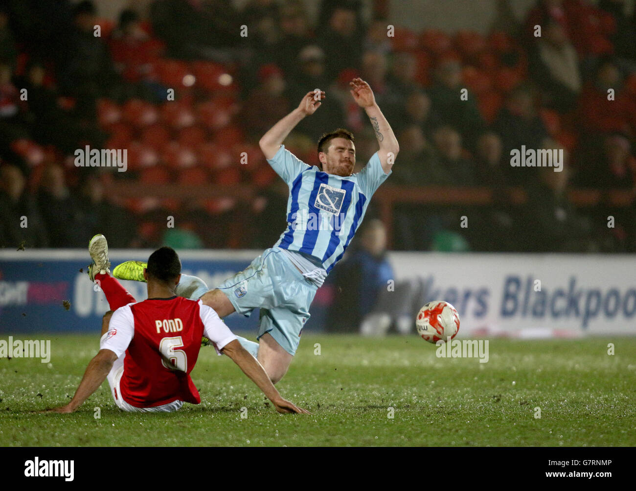 Coventry City's John Fleck is tackled by Fleetwood Town's Nathan Pond ...