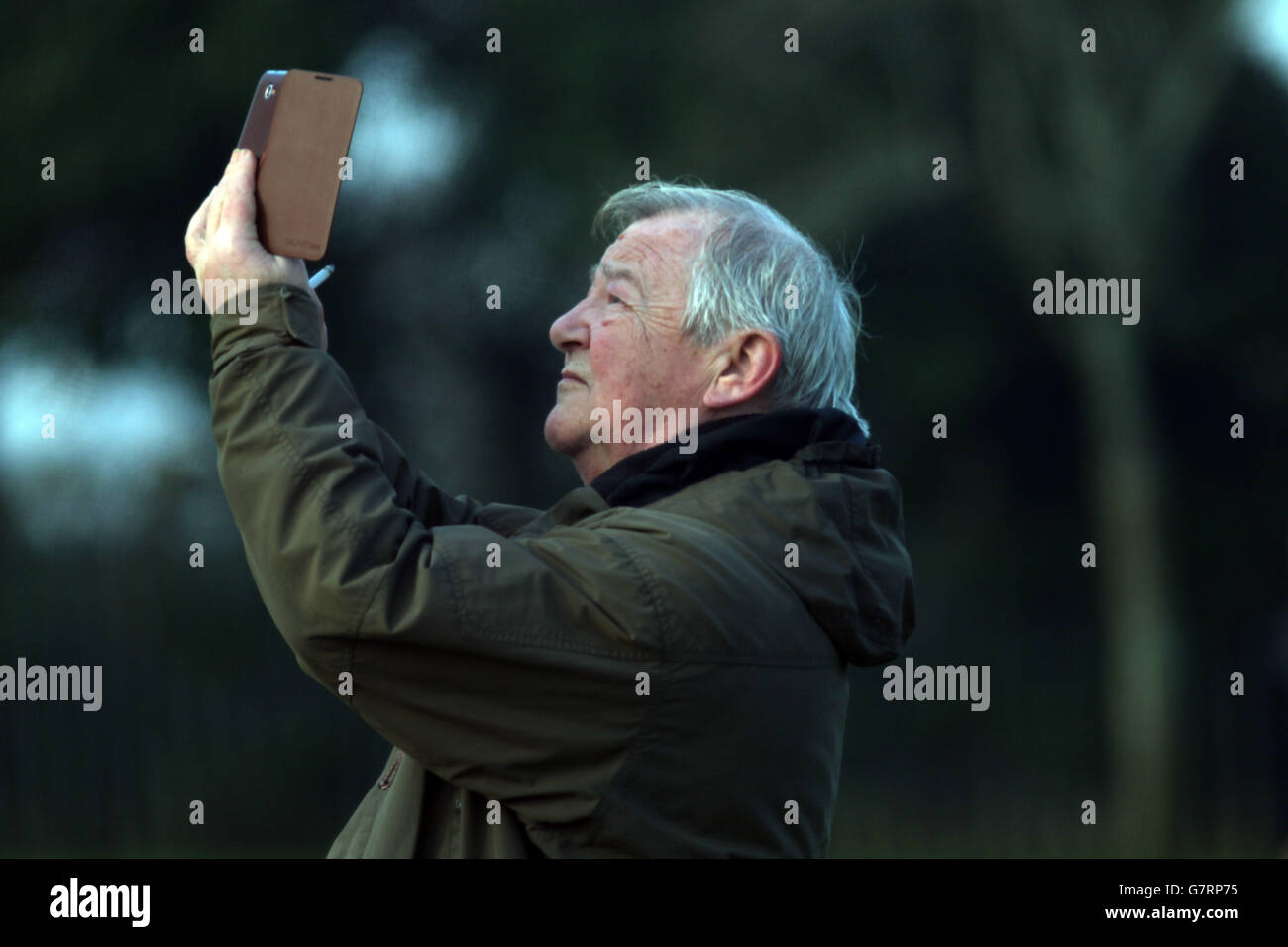 A man watches the eclipse of the sun from Plymouth, Devon, as a near ...