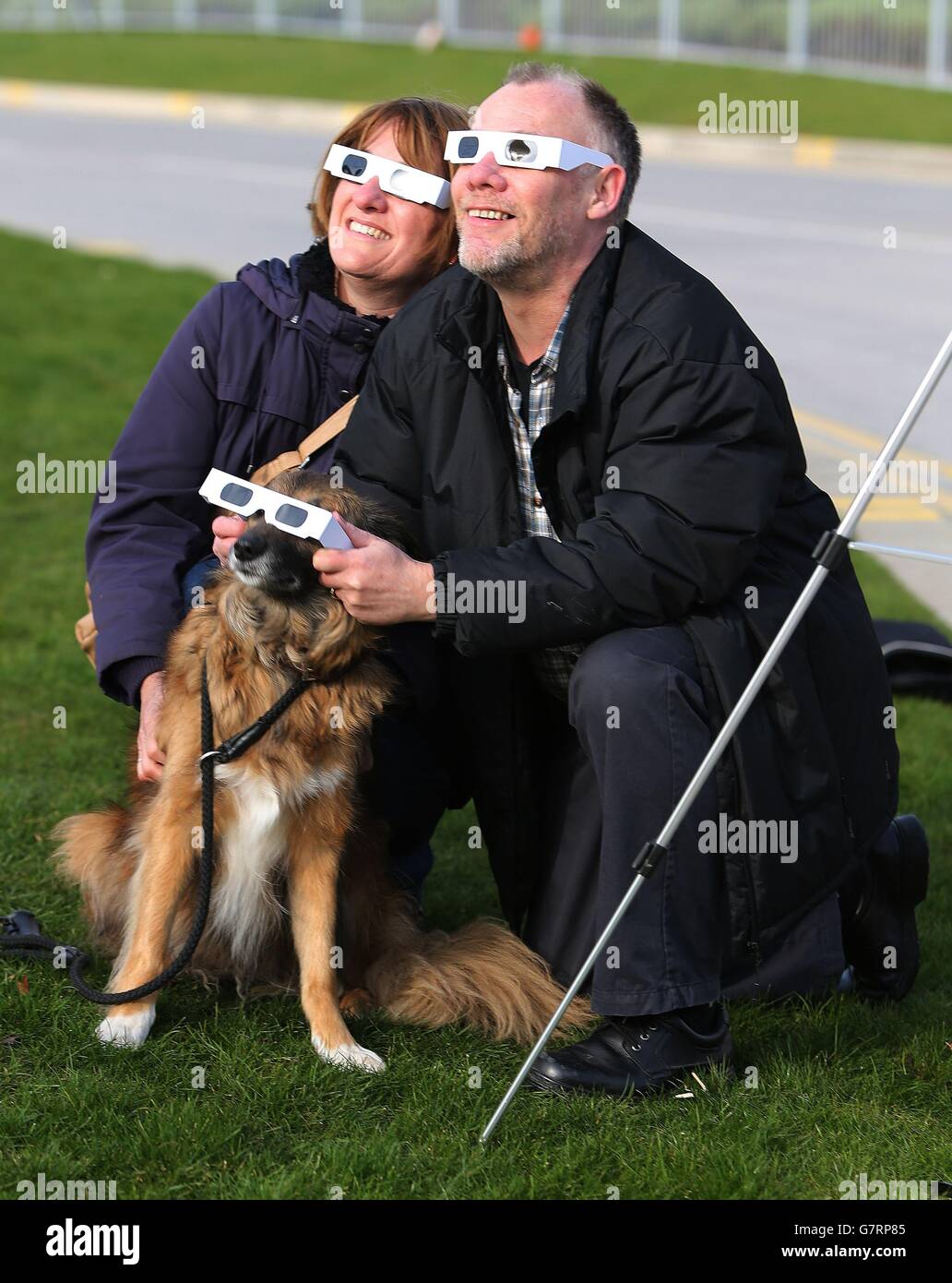 David and Julie Dean and their dog, from Liverpool, wear solar glasses ...