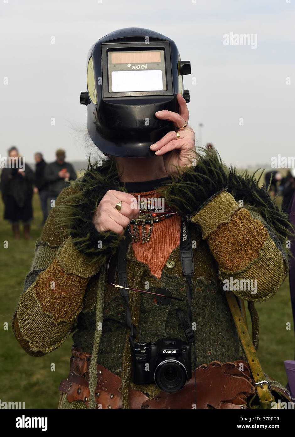 A member of the public uses a welding mask to watch a partial eclipse ...