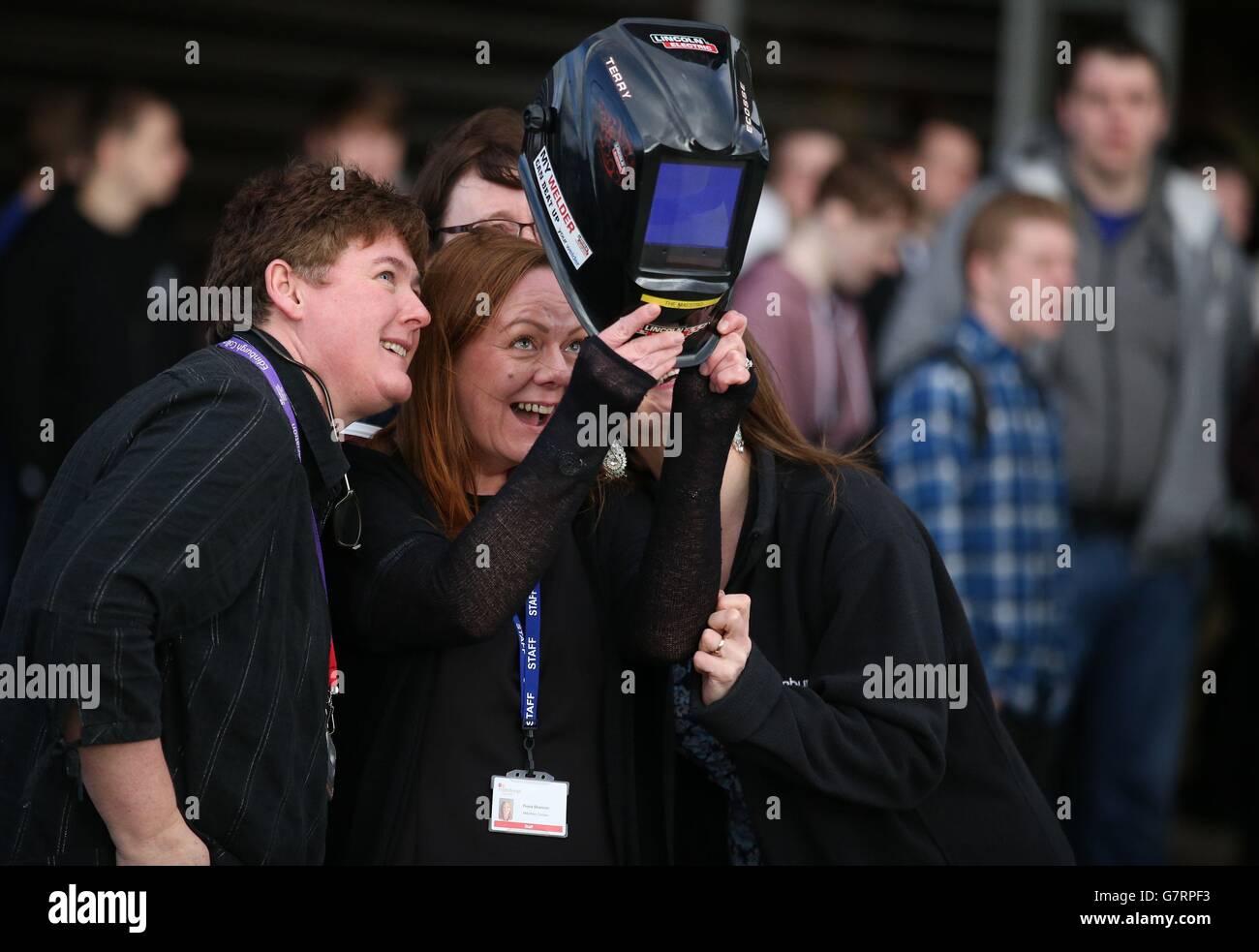 Edinburgh College staff share a welding mask as they view the solar ...